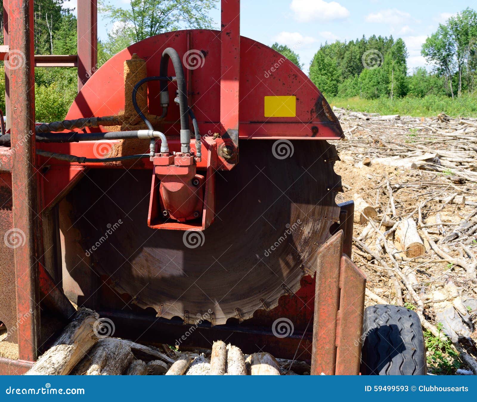 Log Slasher Saw with Tops and Limbs in Background Stock Image - Image ...