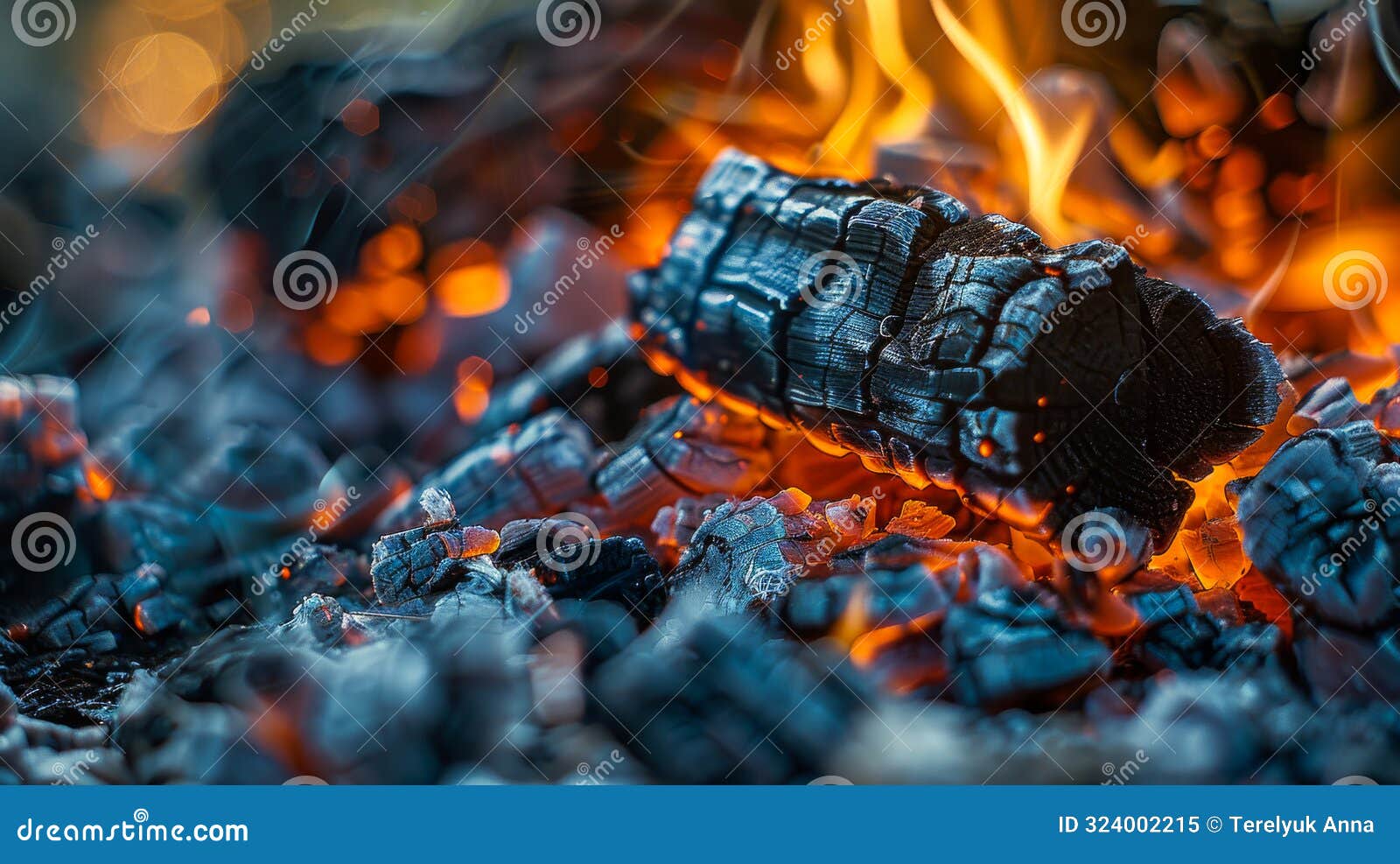 A Log of Wood is Burning in a Pile of Ash. the Fire is Orange and the ...