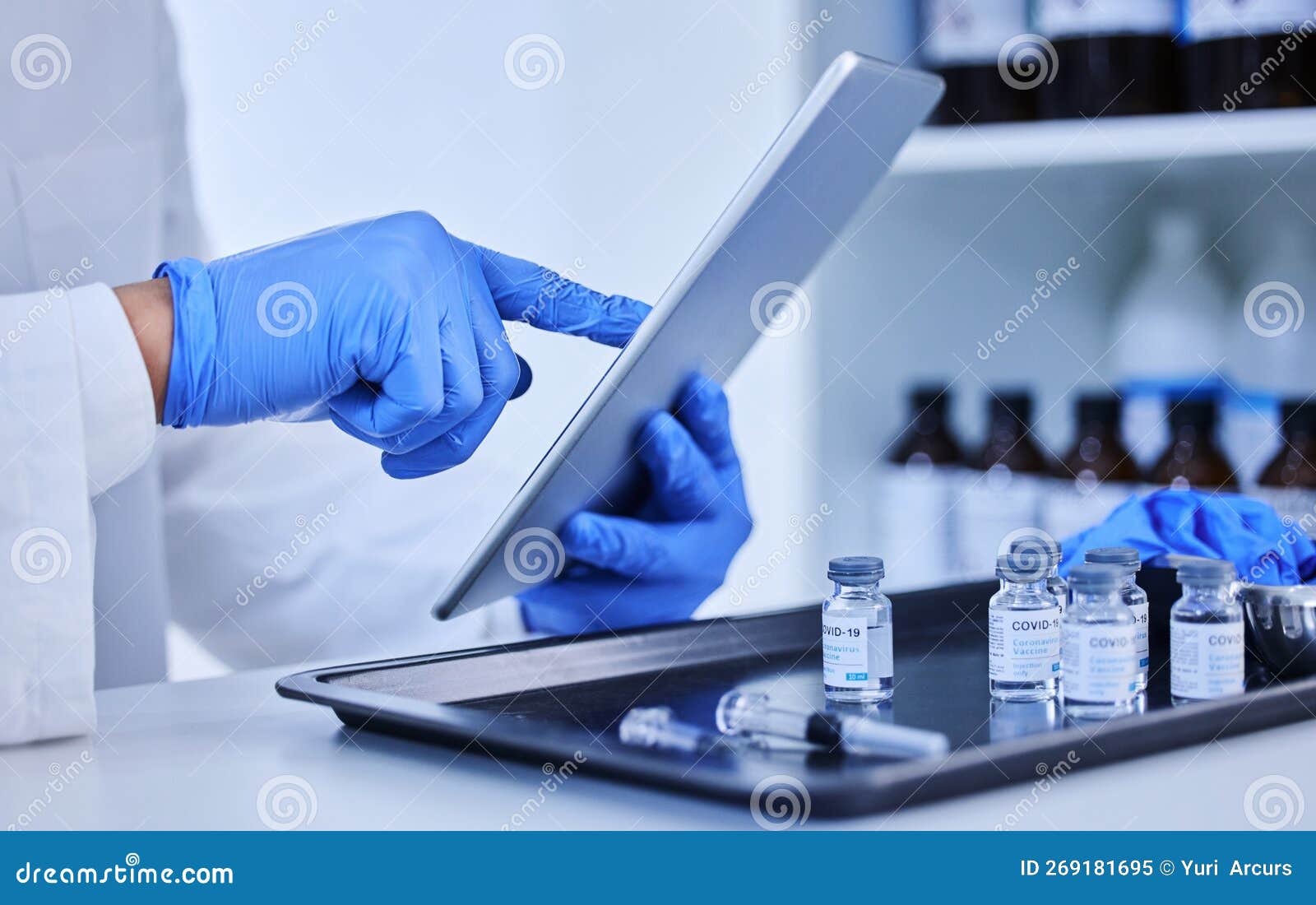 Logging Every Dose. an Unrecognizable Scientist Working on a Tablet in ...