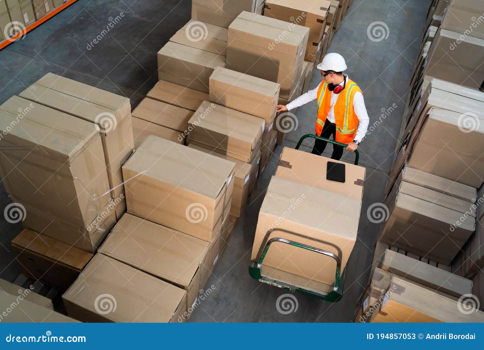 Logistic Warehouse Worker Delivering Boxes on a Trolley. Stock Image ...