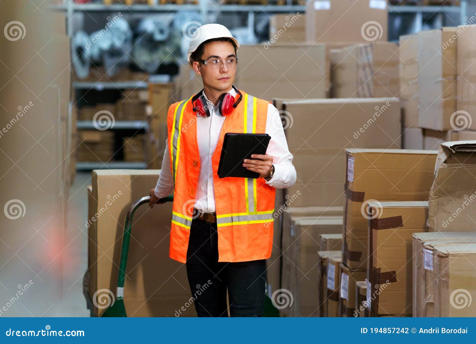 Logistic Warehouse Worker Delivering Boxes on a Trolley. Stock Photo ...
