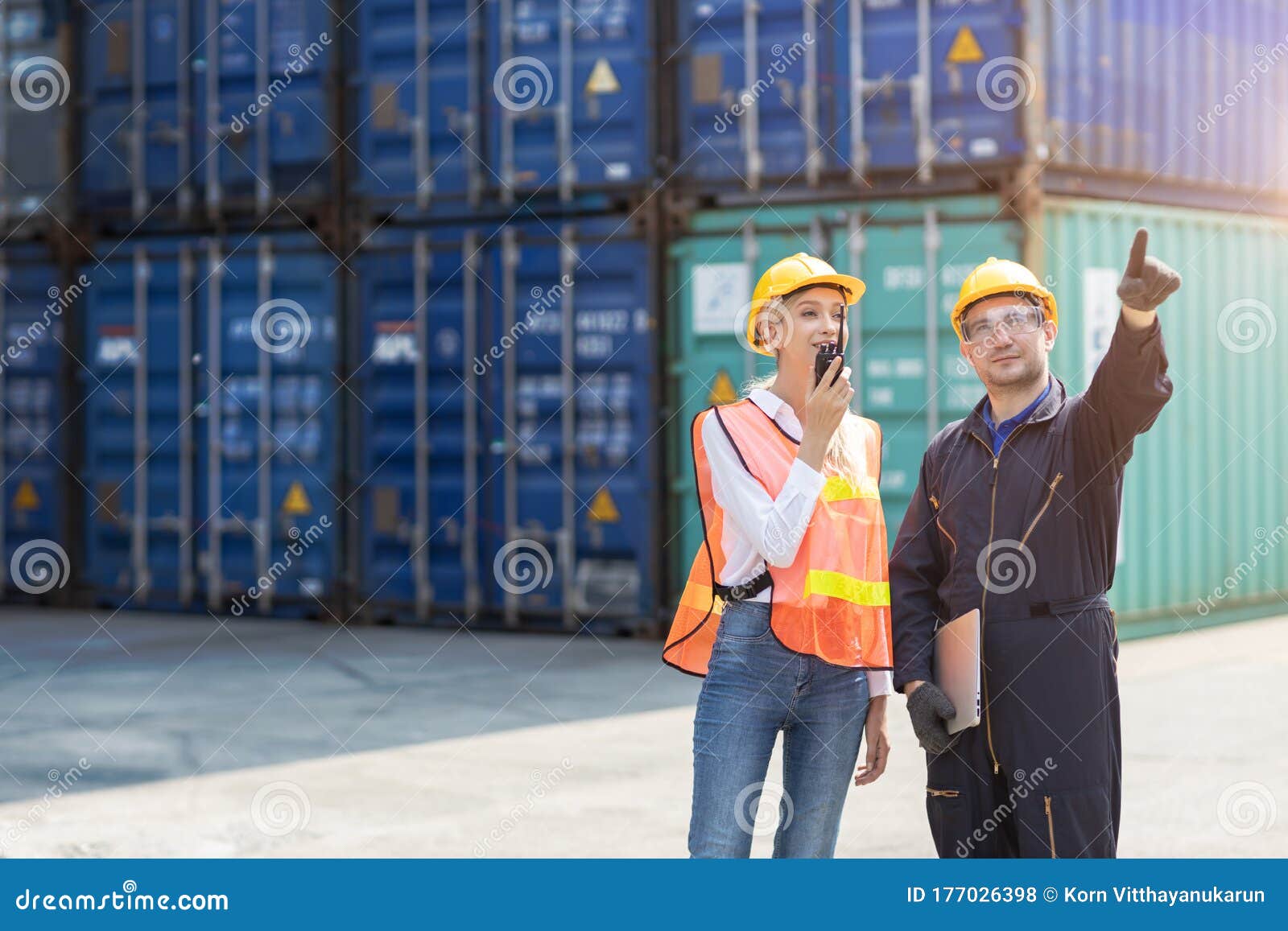 Logistic Worker Man And Woman Working Team With Radio Control Loading Containers At Port Cargo