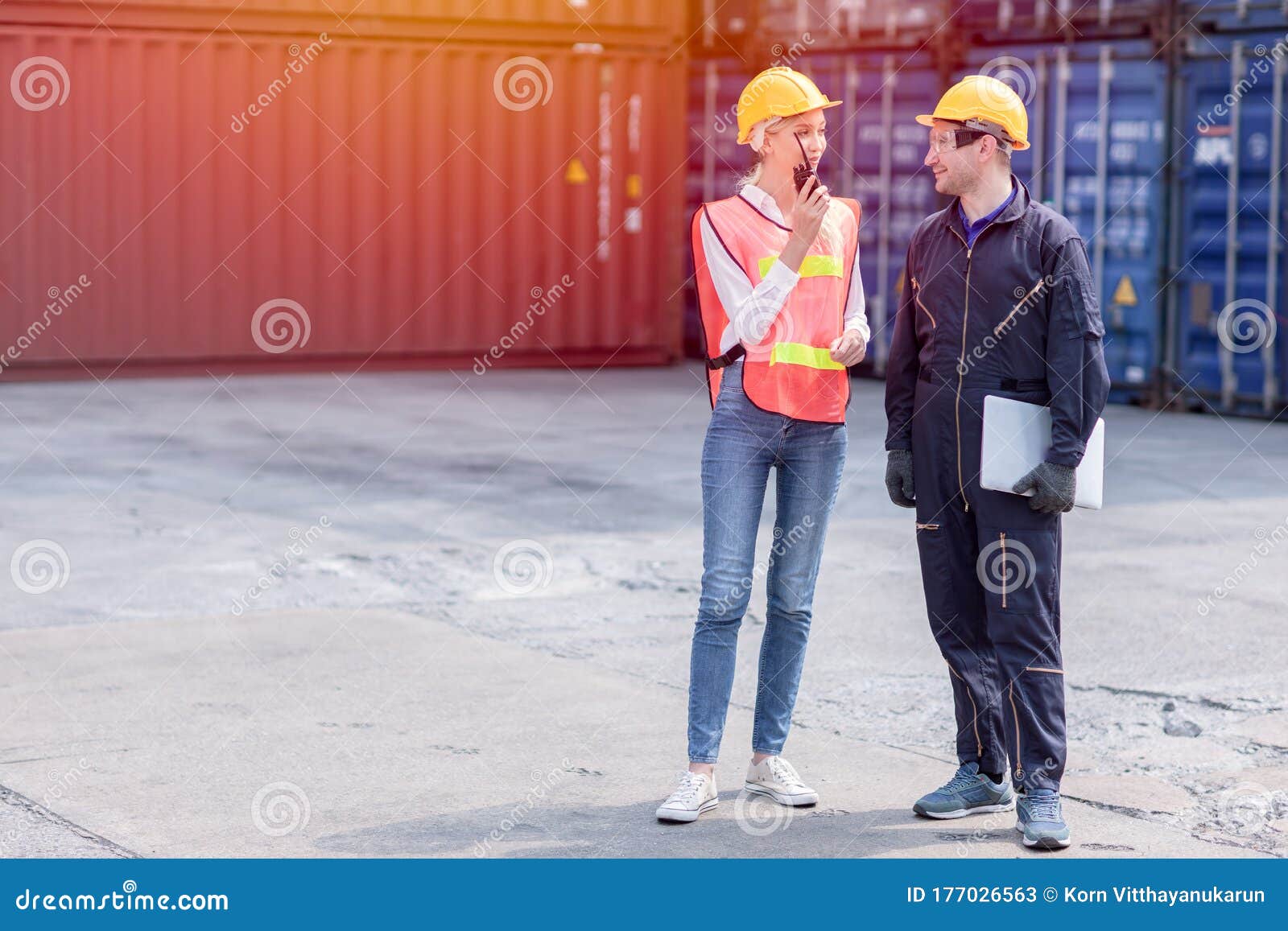Logistic Worker Man And Woman Working Team With Radio Control Loading Containers At Port Cargo