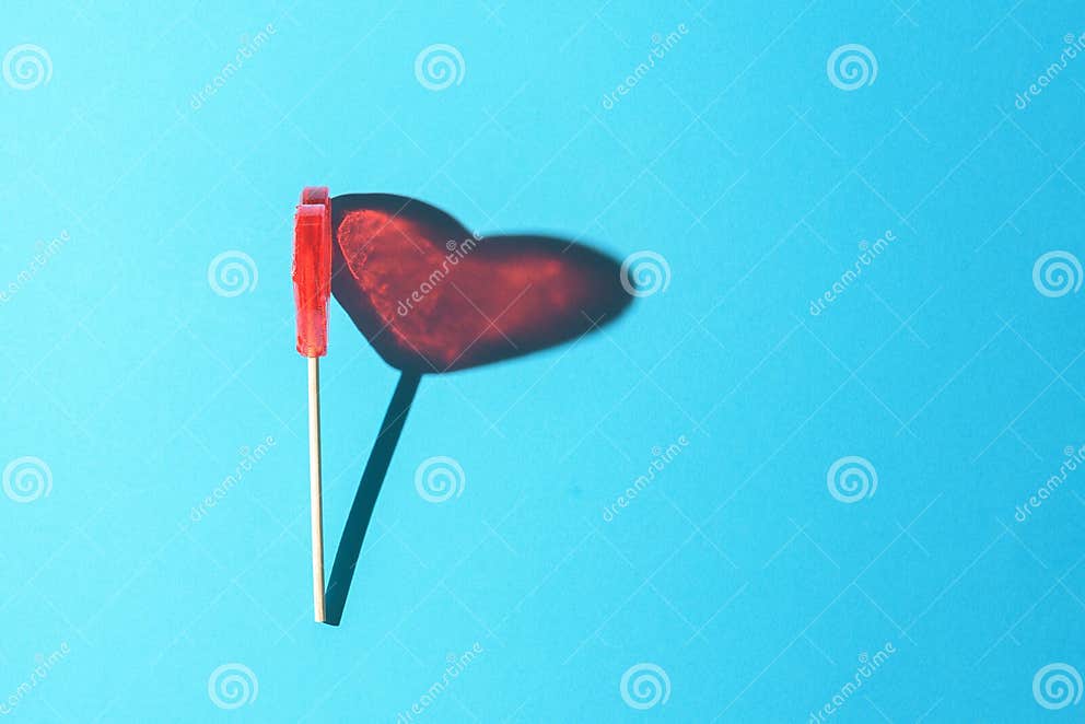 Lollipop in the Form of a Heart on a Blue Background with a Sharp ...