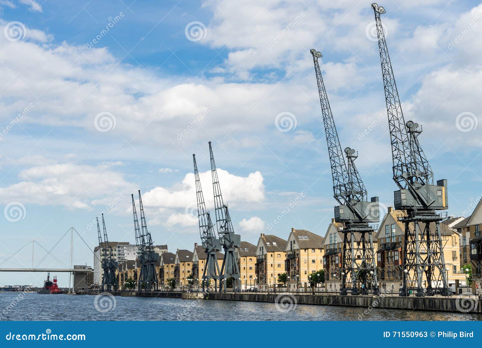 LONDON - JUNE 25 : Old Dockside Cranes Alongside a Waterfront De ...
