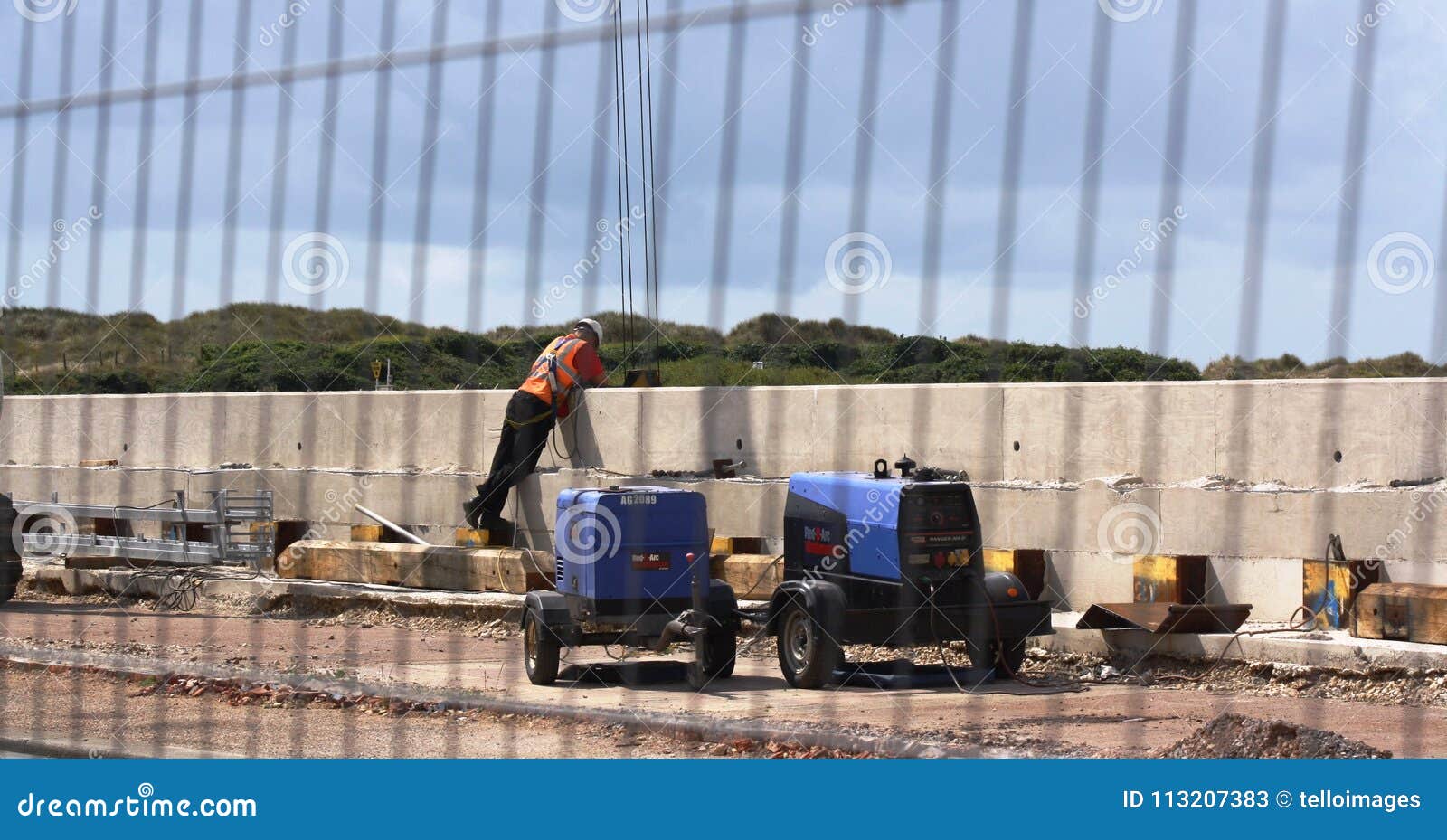 Construction Worker Looking Over the Edge of a Bridge Editorial Stock ...