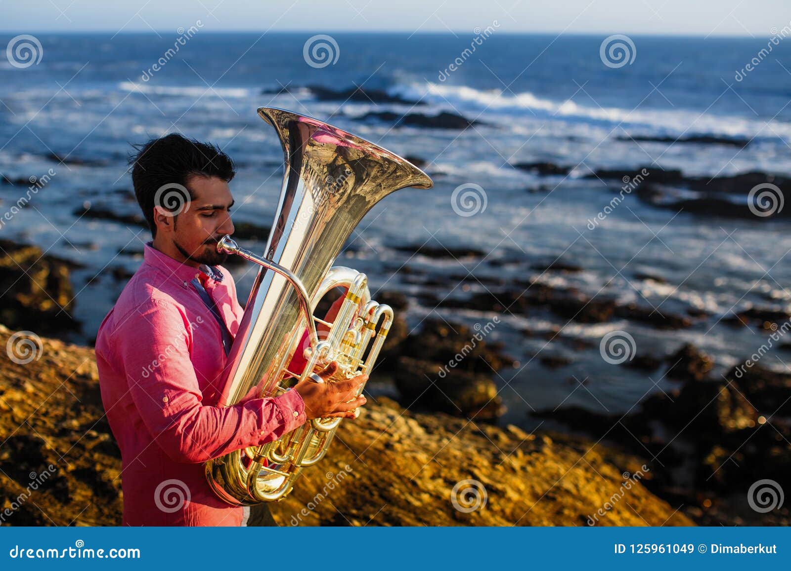 Lone Musician Playing the Tuba on the Ocean Coast. Stock Image - Image ...