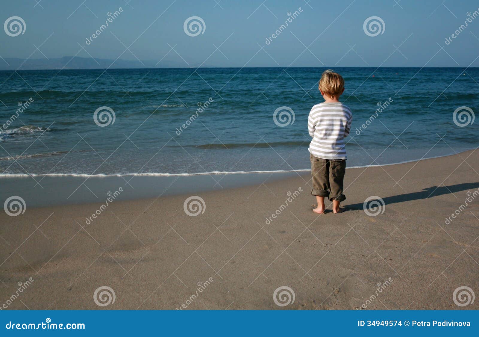 Lonely boy on the beach stock photo. Image of luck, happiness - 34949574