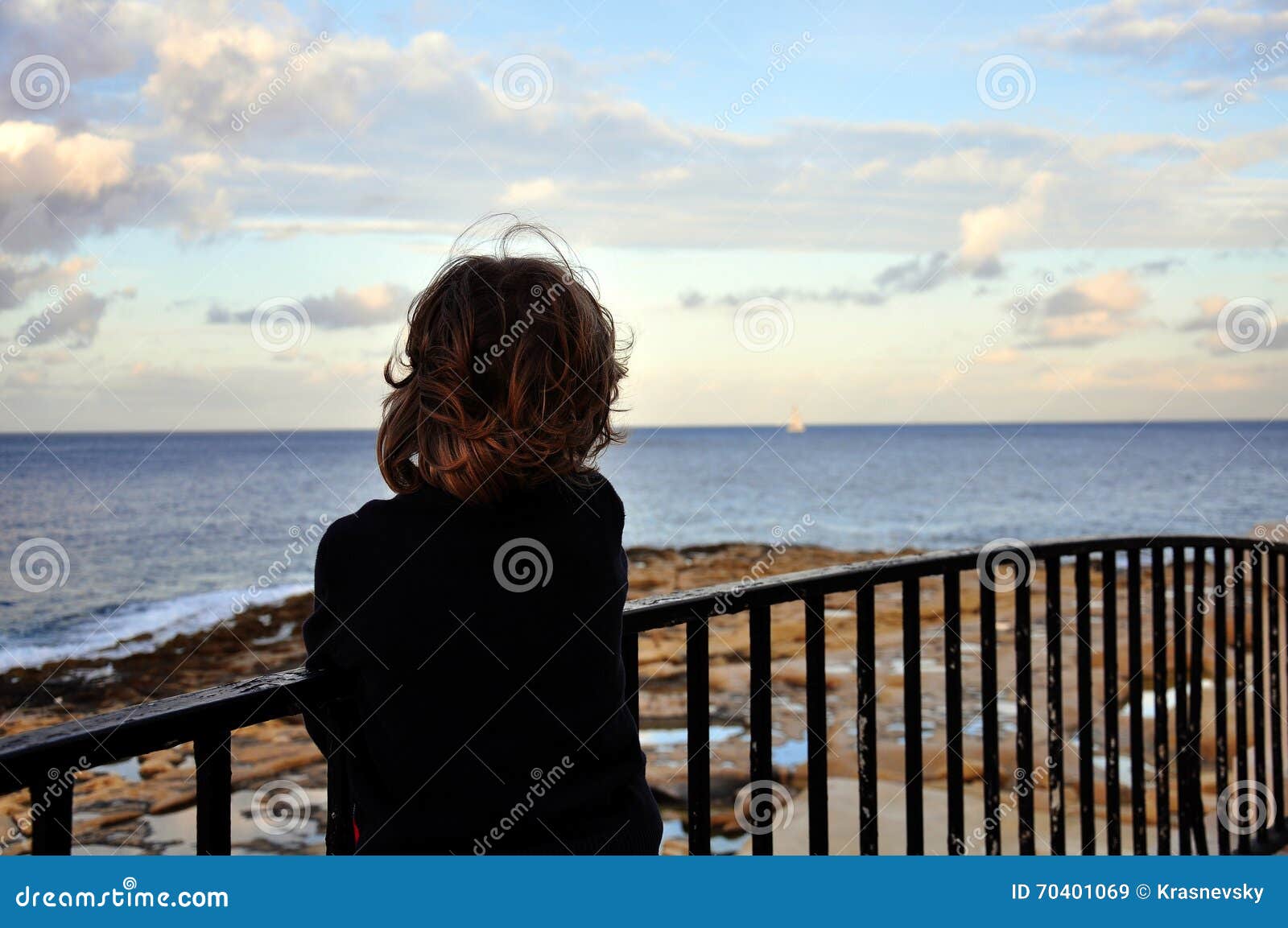 Lonely boy looking at sea stock image. Image of male - 70401069