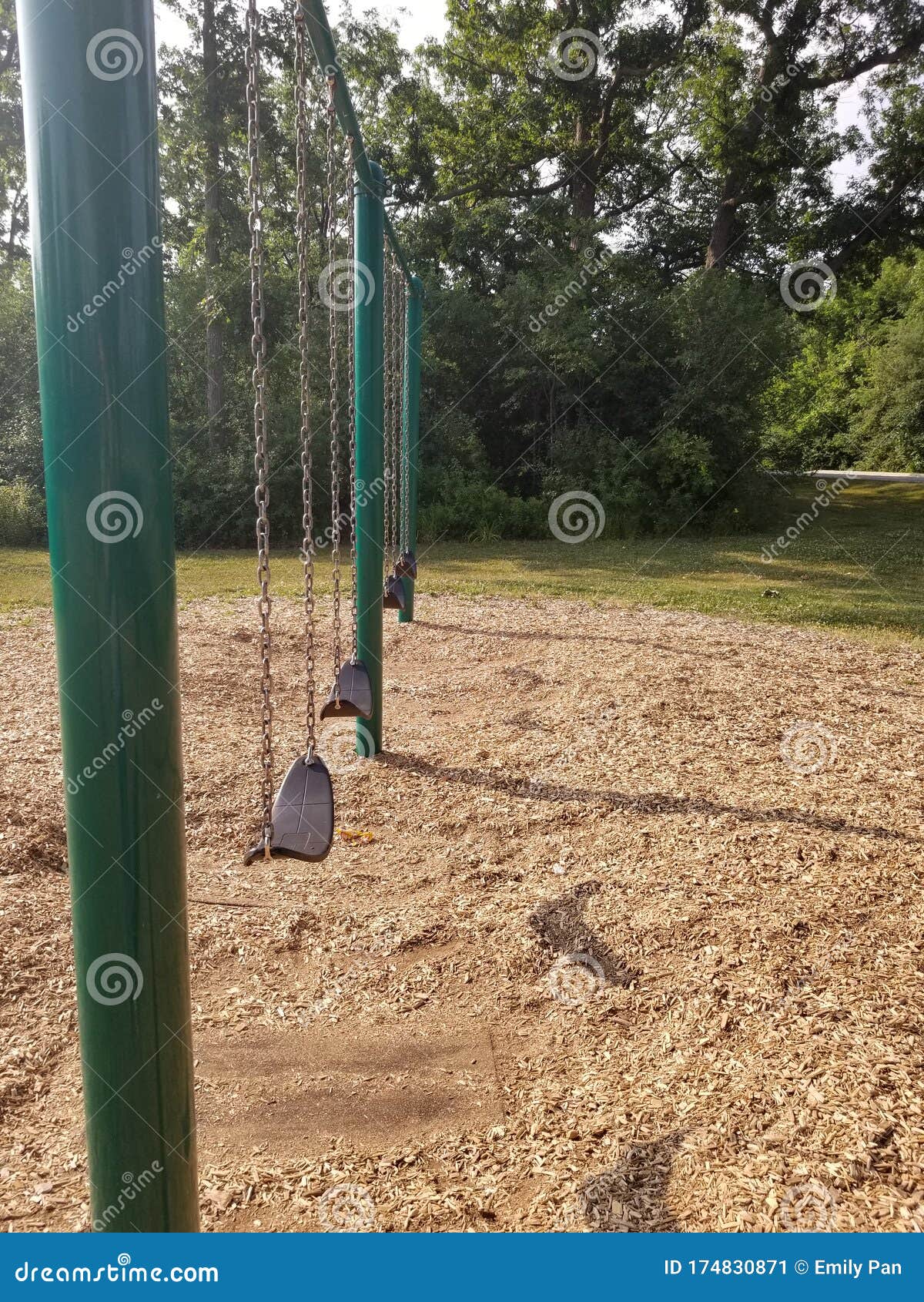 A Lonely Green Swing Set in a Playground Stock Image - Image of lonely ...