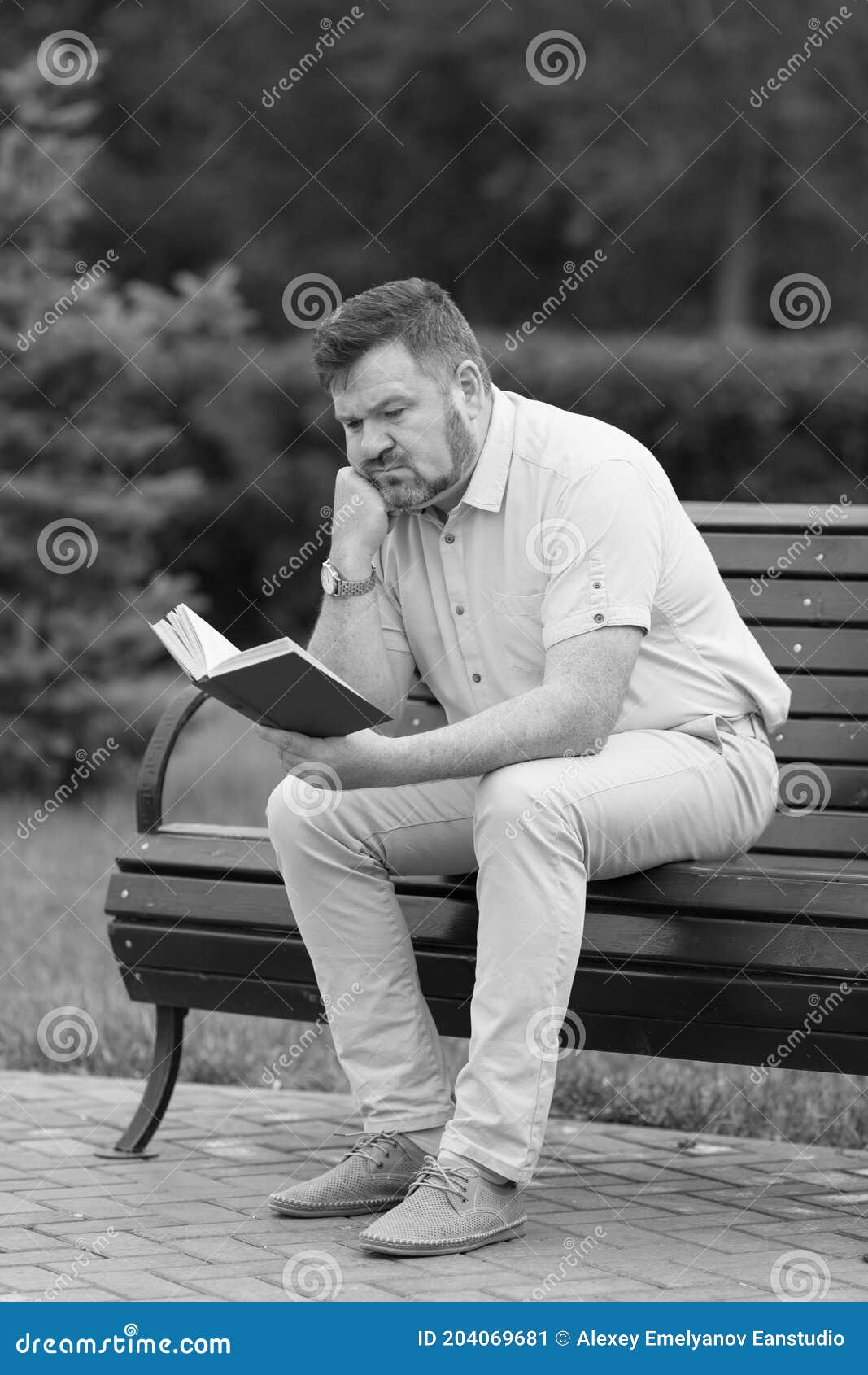 Lonely Man Reading a Book on the Bench in His Spare Time Stock Image ...