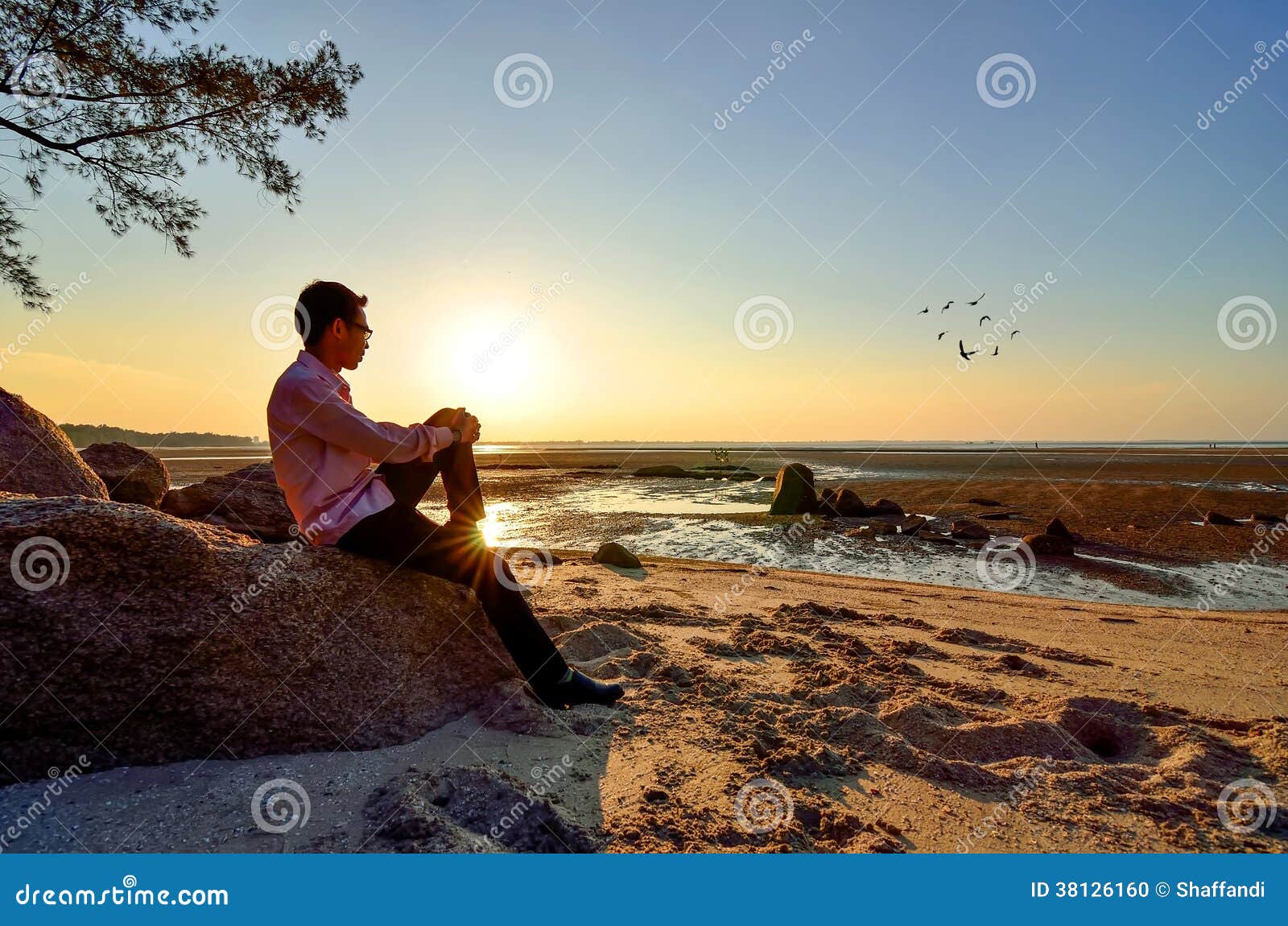 A Lonely Man Sitting on the Rock Stock Photo - Image of looking, high ...
