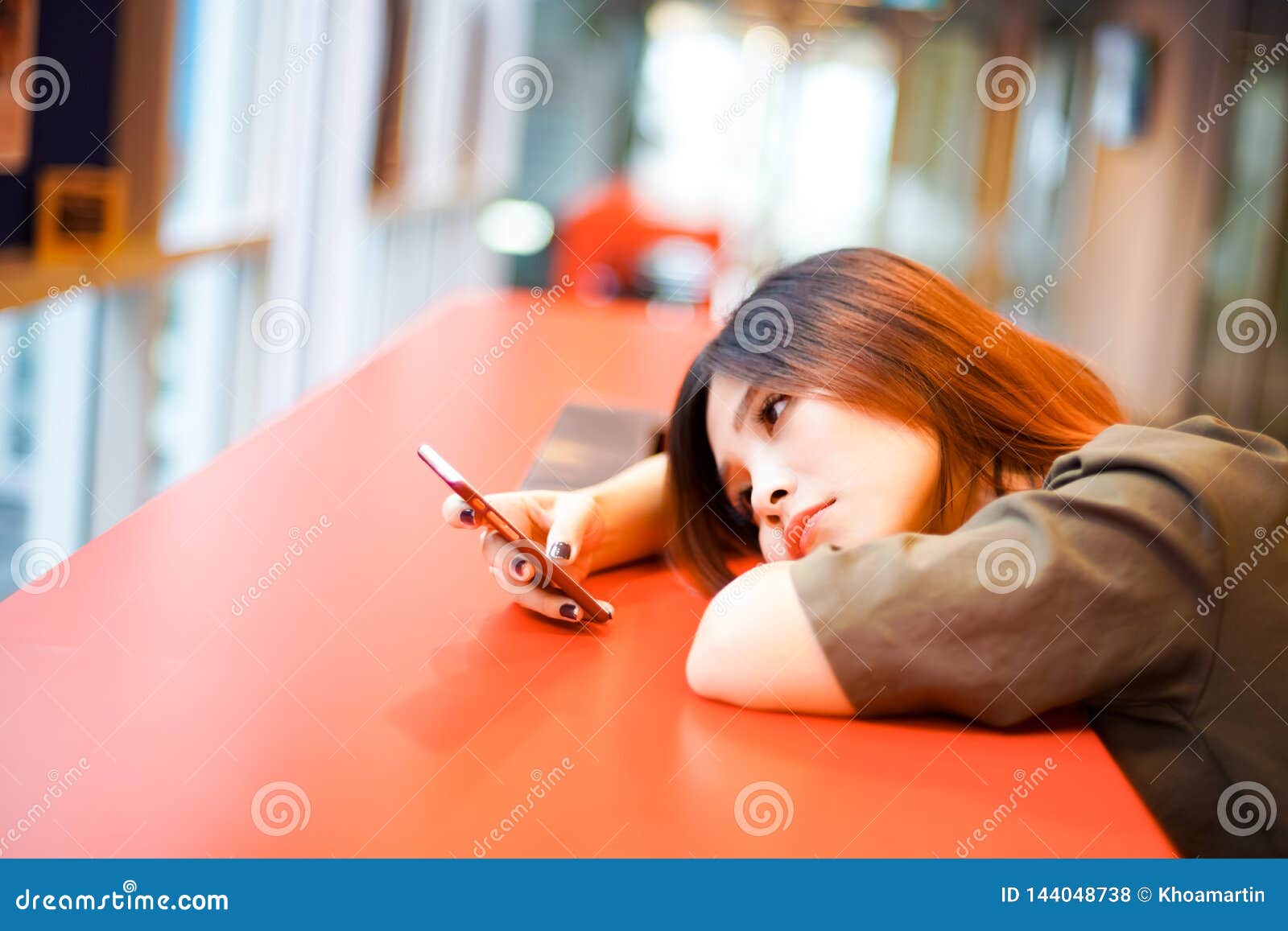 Lonely Sad Girl Waiting for Text Message from Smartphone Lying on the ...