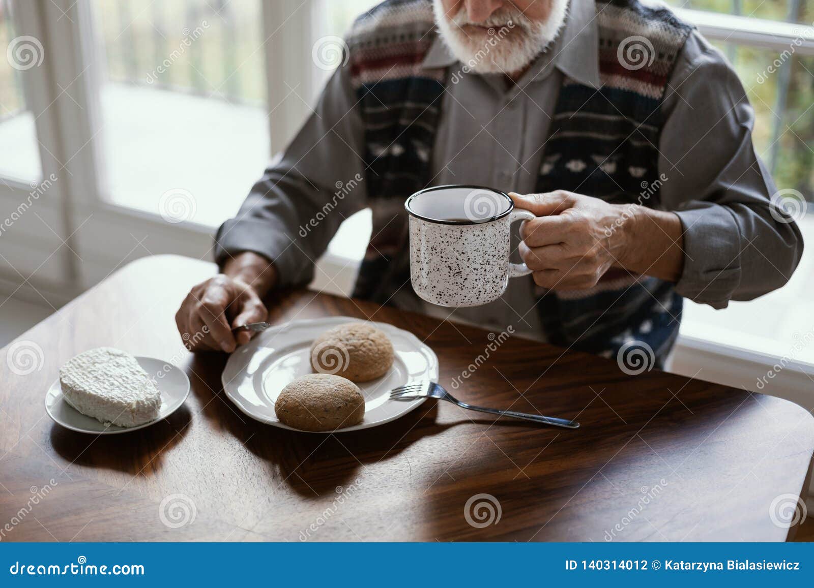 Lonely Senior Man Sitting at Kitchen Table Drinking Tea Stock Photo ...