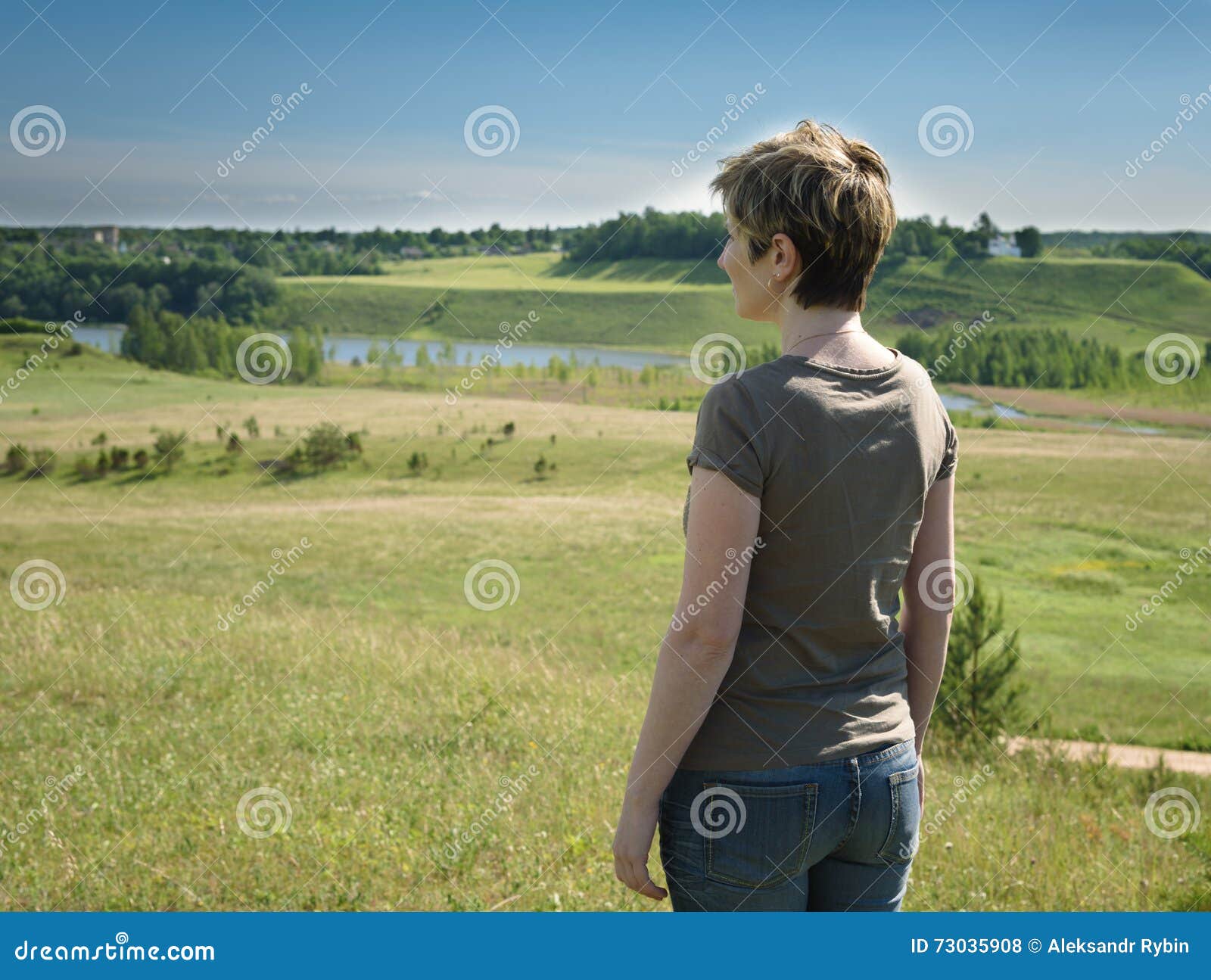 Lonely Woman Standing with Her Back on Green Field Stock Photo - Image ...