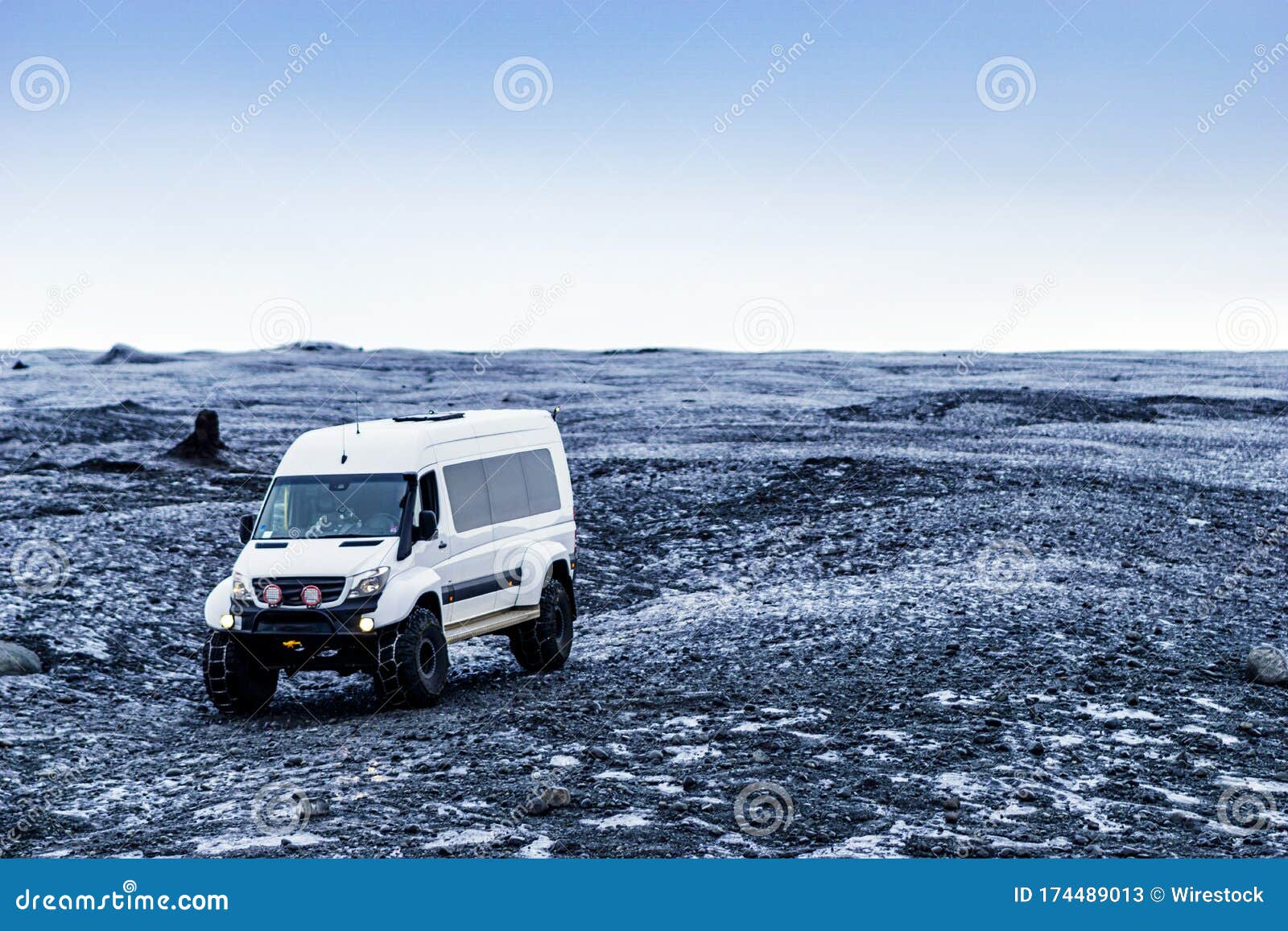 Long Angle Shot of a White Tourist Van on a Gravel Plain Stock Image ...