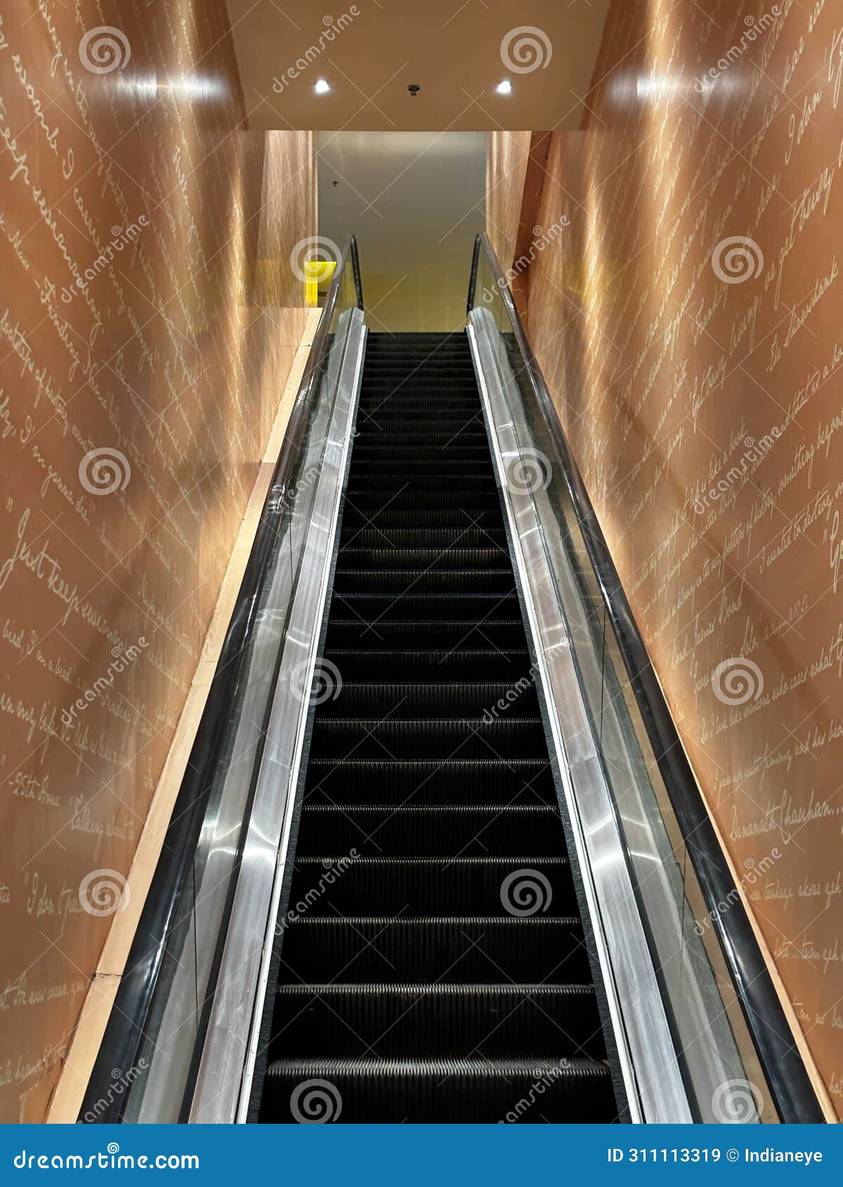 A Long Black Escalator with a Wall of Text Behind it Stock Image ...