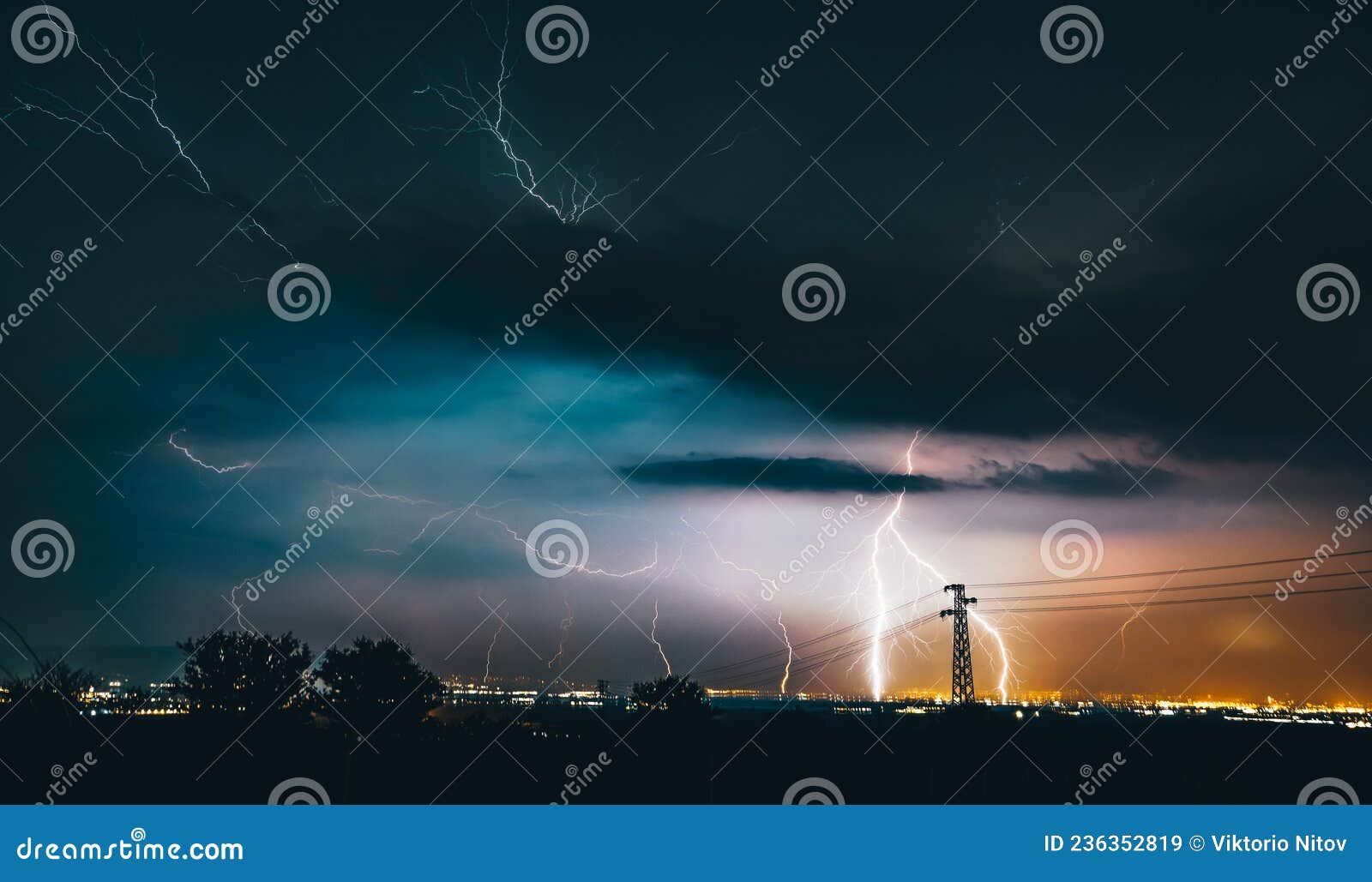 Long, Branched, Powerful Lightning Bolts Strike Down Behind the Trees ...