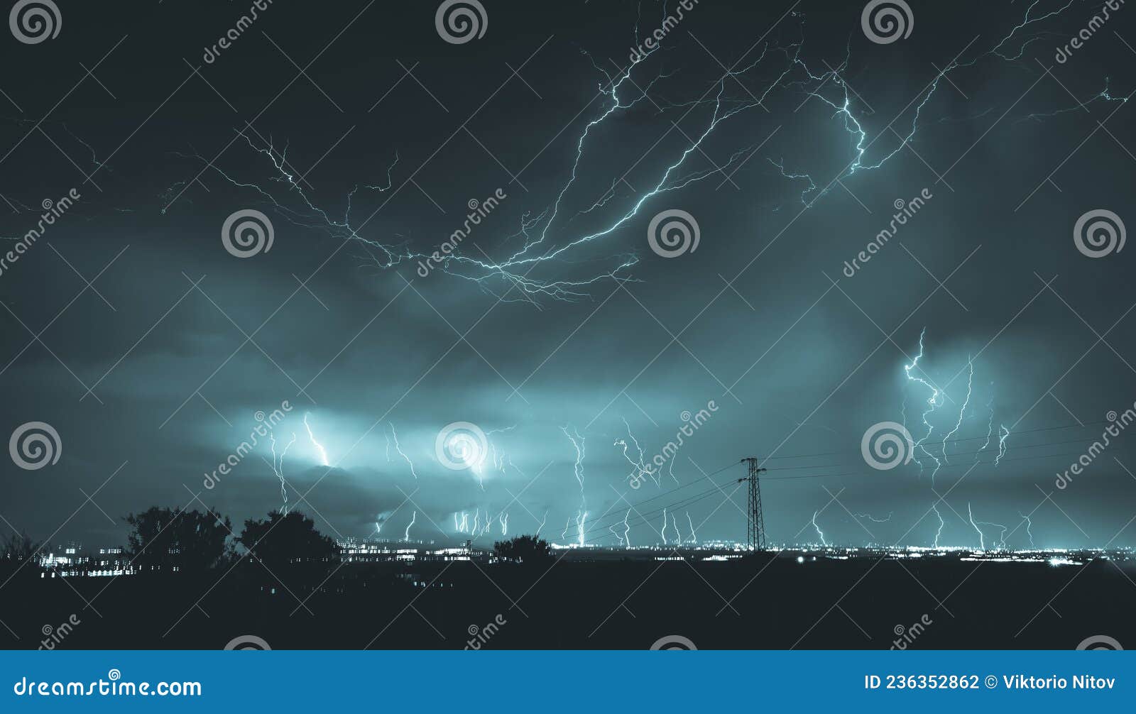 Long, Branched, Powerful Lightning Bolts Strike Down Behind the Trees ...