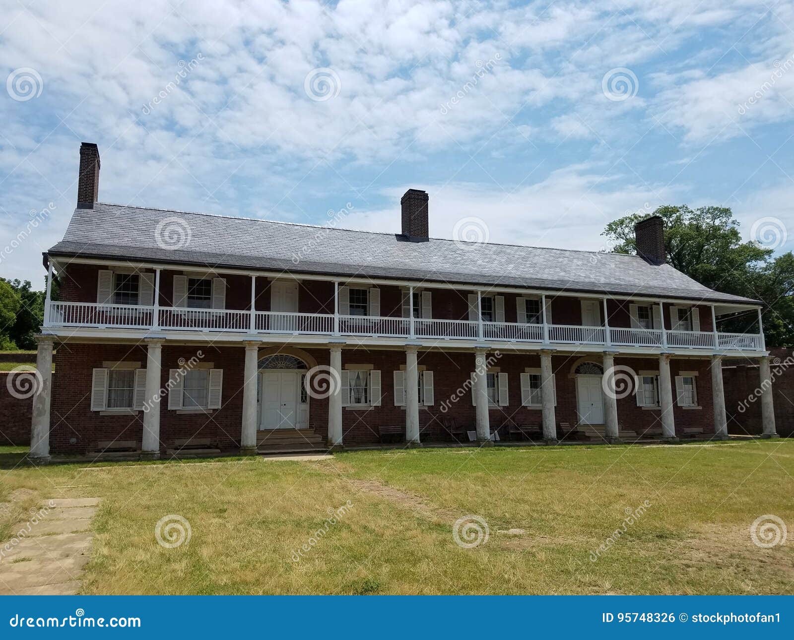 Long Brick Building with White Columns Stock Photo - Image of building ...
