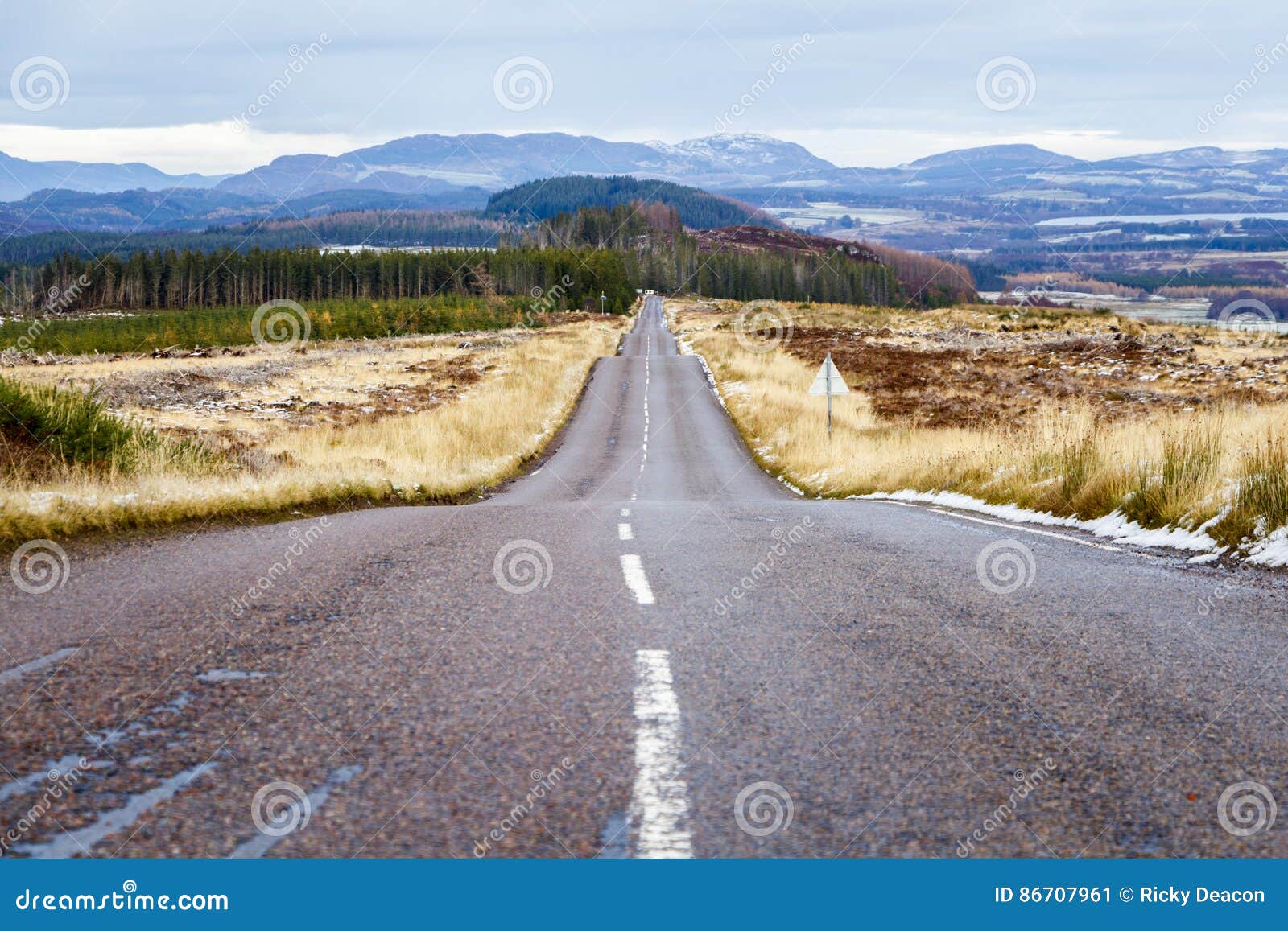 Straight And Bumpy Mountain Road Across Rocky Landscape. Royalty-Free ...
