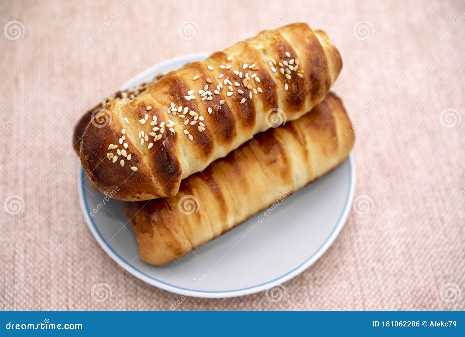Long Bun with Sesame Seeds on a Plate Stock Photo - Image of cooking ...