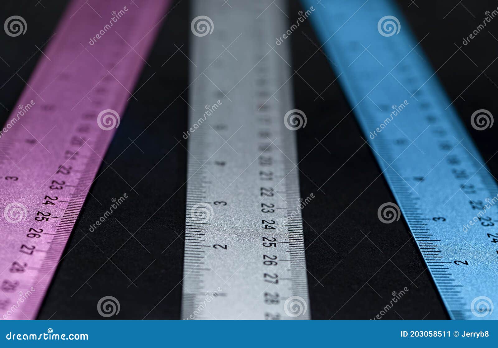 Long Colorful Metal Rulers on Black Tabletop Stock Image - Image of ...