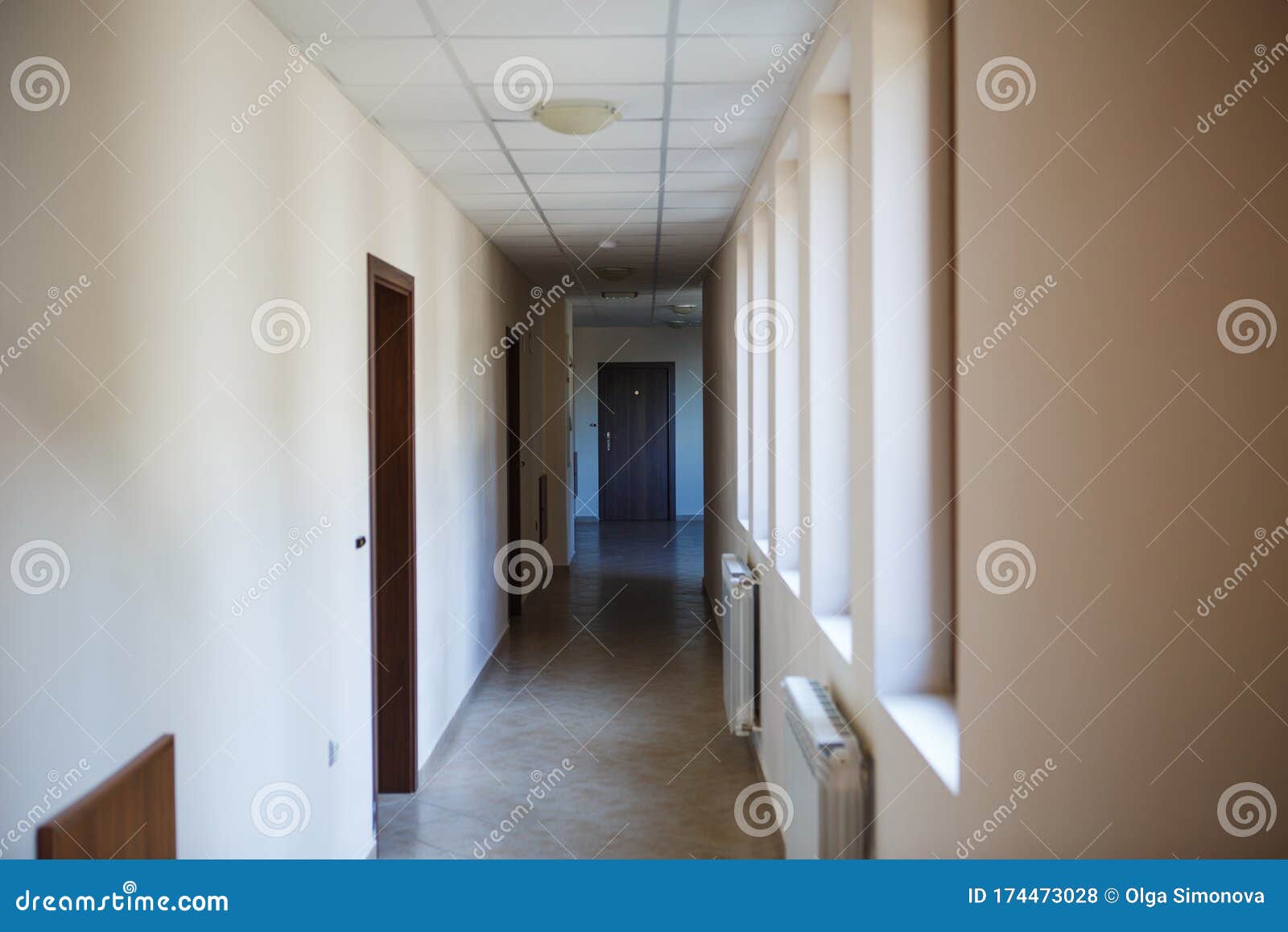 A Long Corridor in the Hotel with Windows and Doors. Stock Photo ...