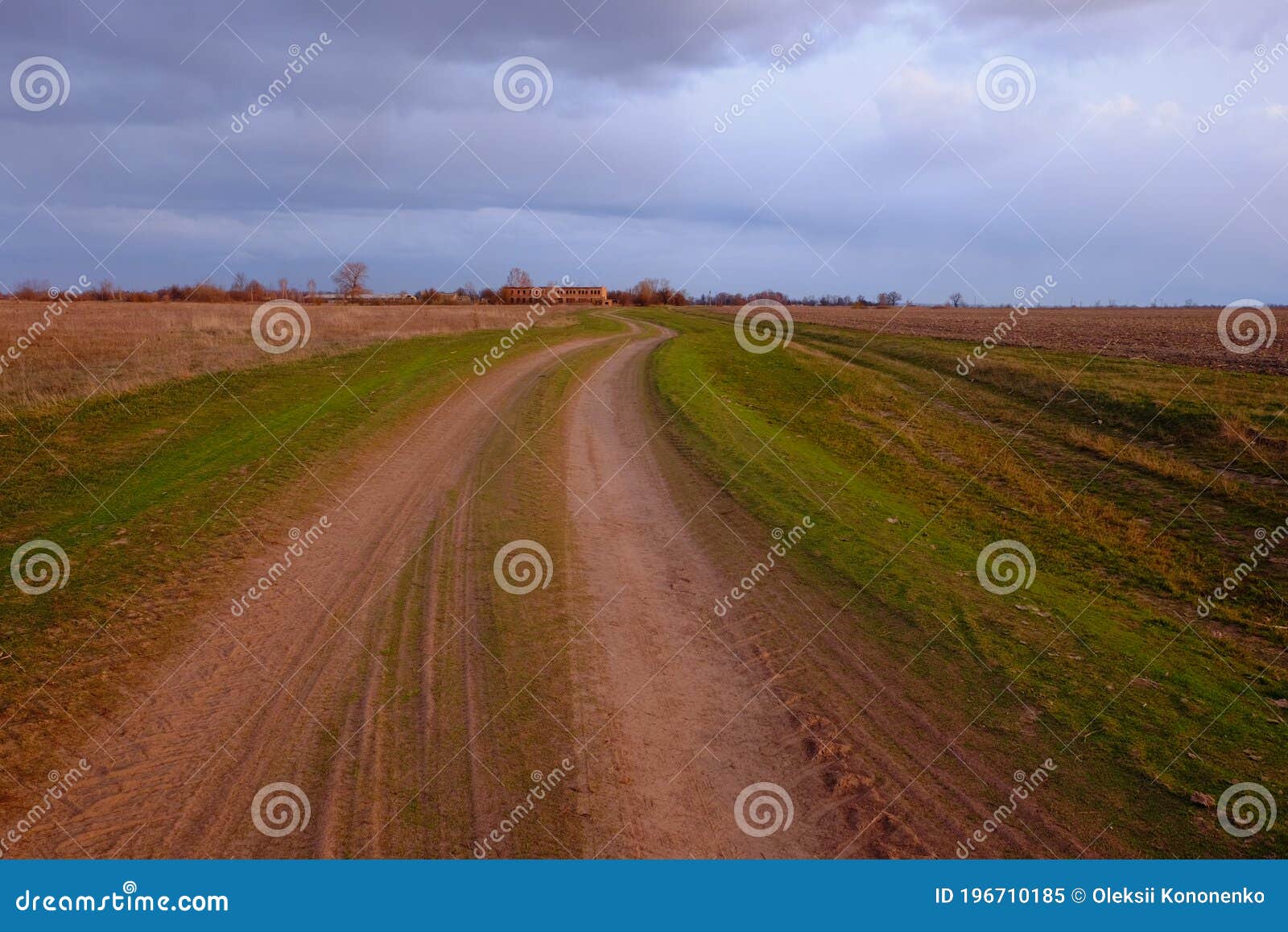 Long Dirt Road in the Fields. Cloudy Evening Landscape Stock Image ...