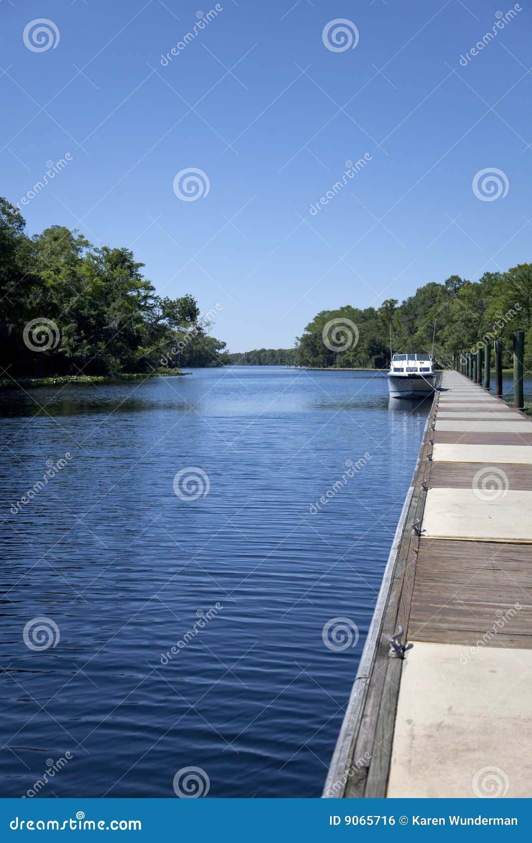 Long Dock with Boat on a River Stock Photo - Image of dock, sheltered ...