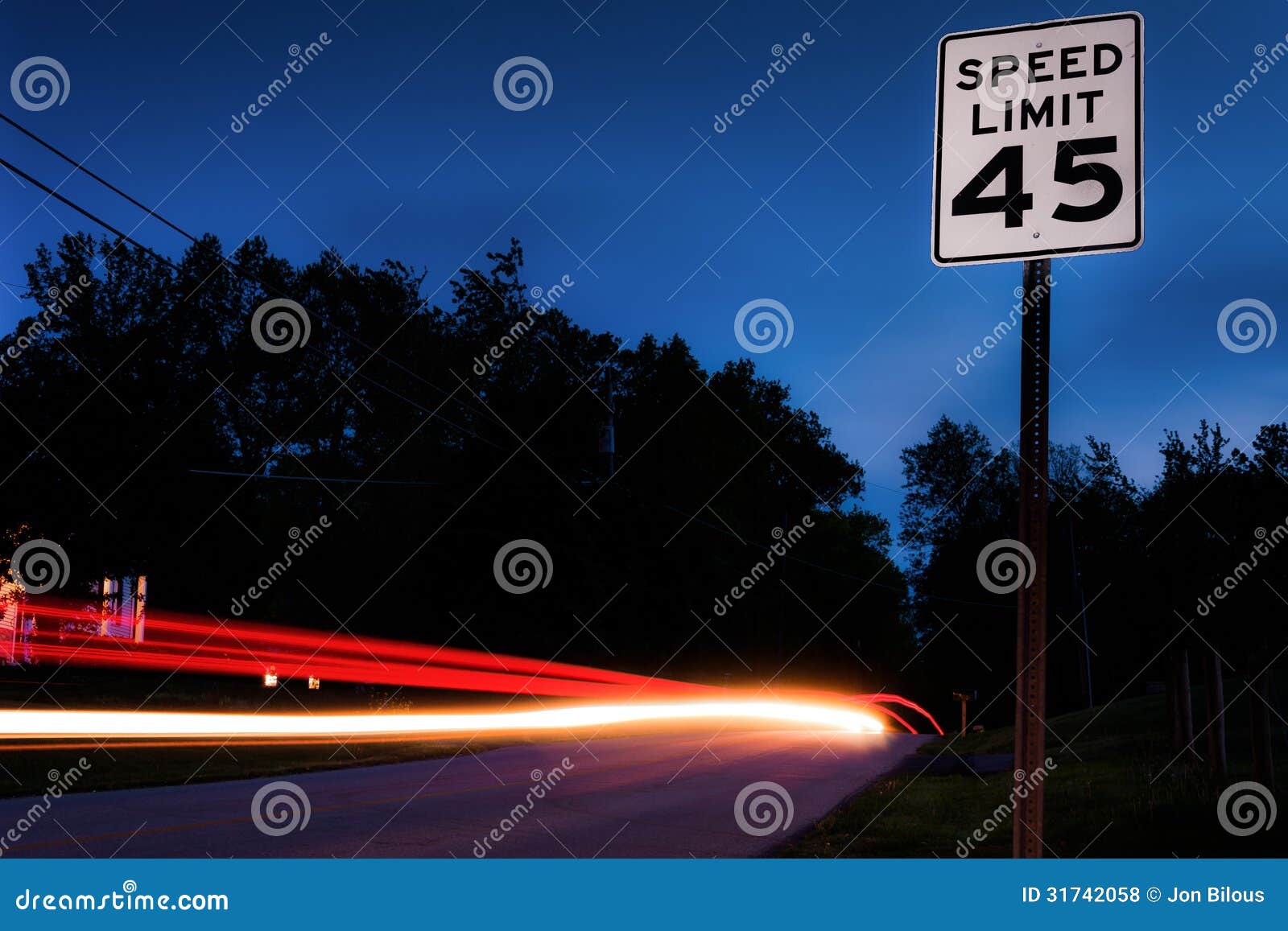 Long Exposure of Cars Passing by a Speed Limit Sign Stock Photo - Image ...
