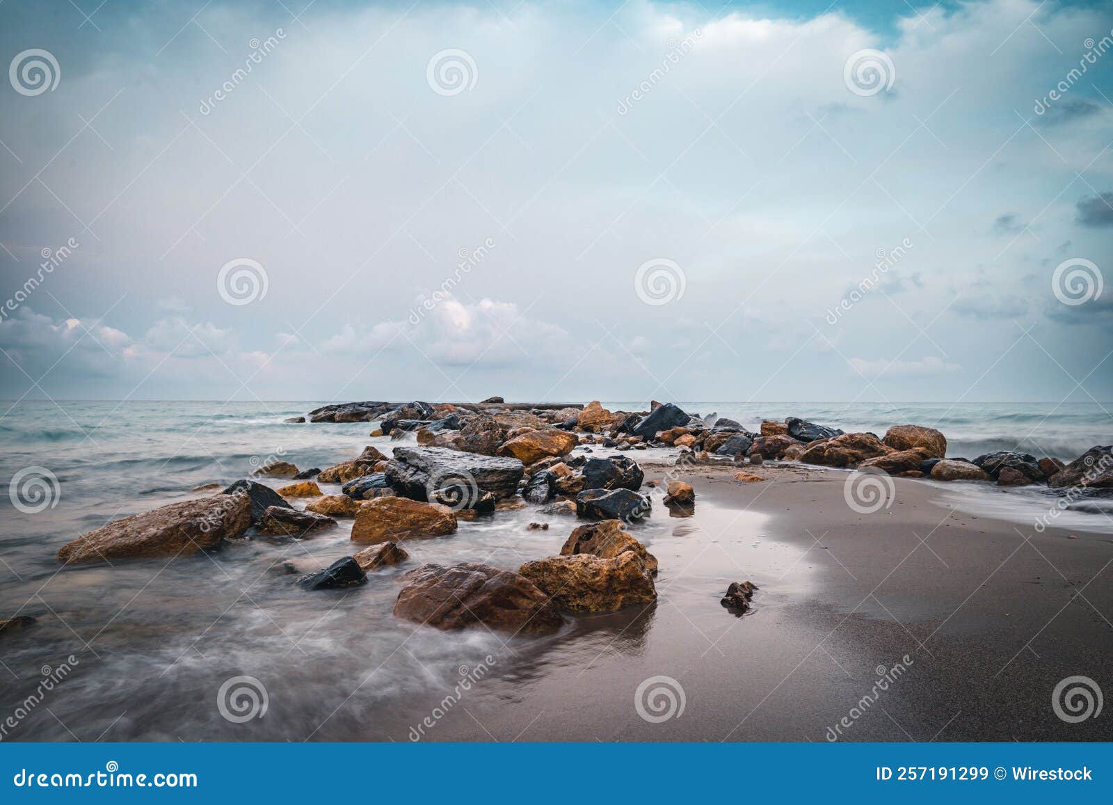 Long Exposure Effect of Ocean Waves Hitting the Sandy Beach with Stones ...