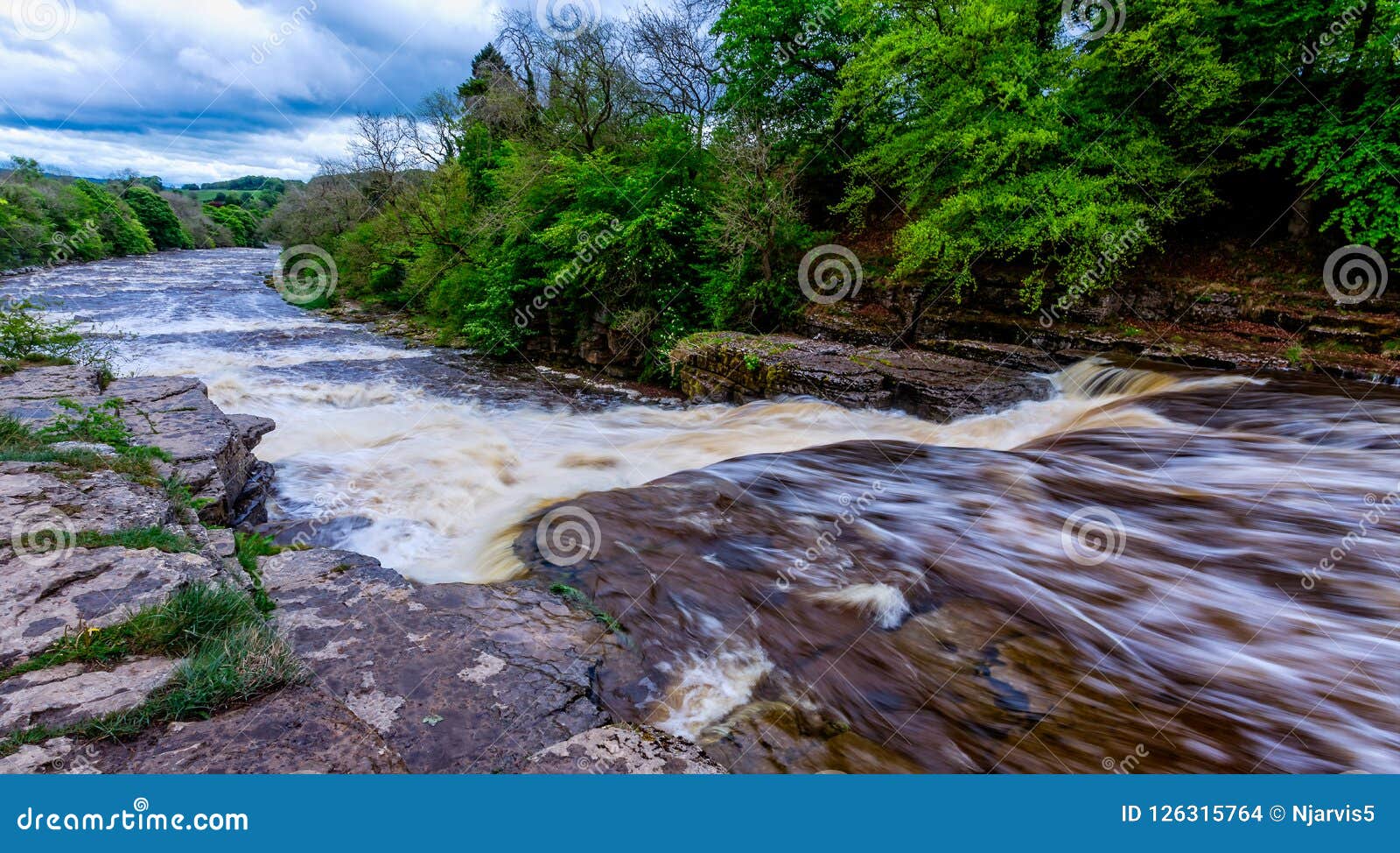 Long Exposure of Raging Water Cascading Down River Stock Photo - Image ...