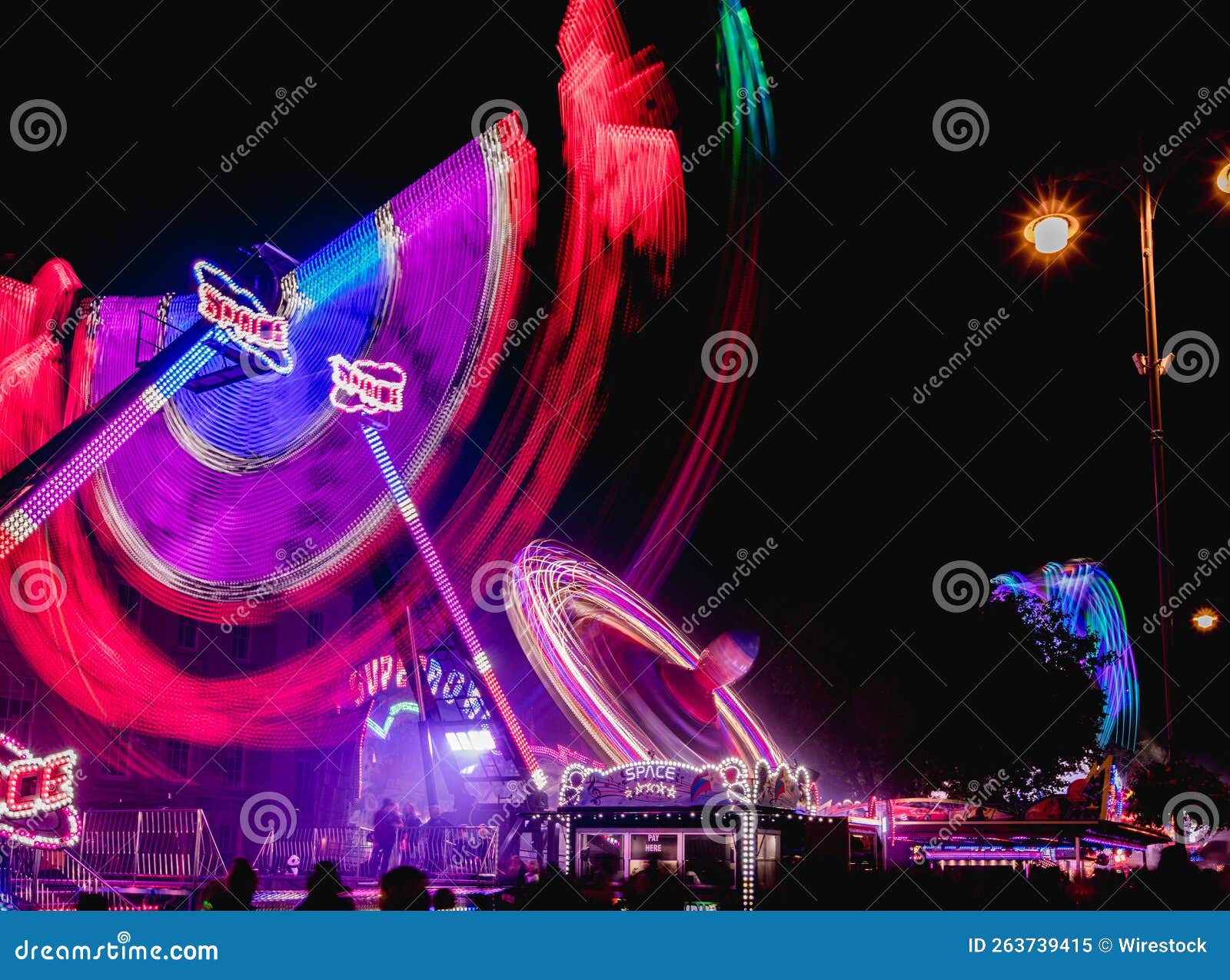 Long Exposure Shot of Glowing Illuminated Rides at the Annual Street ... Long Exposure Shot of Glowing Illuminated Rides at the Annual Street ...