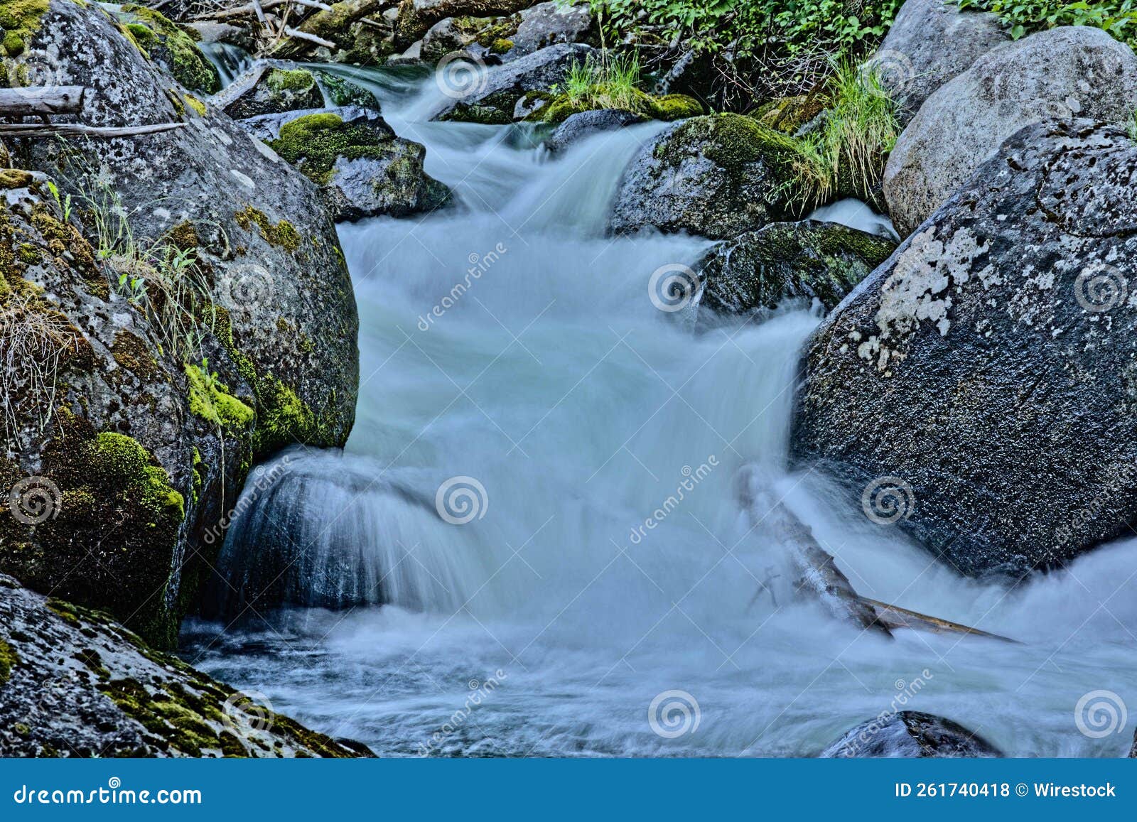 Long Exposure Shot of a Waterfall Streaming between Rocks with Greenery ...