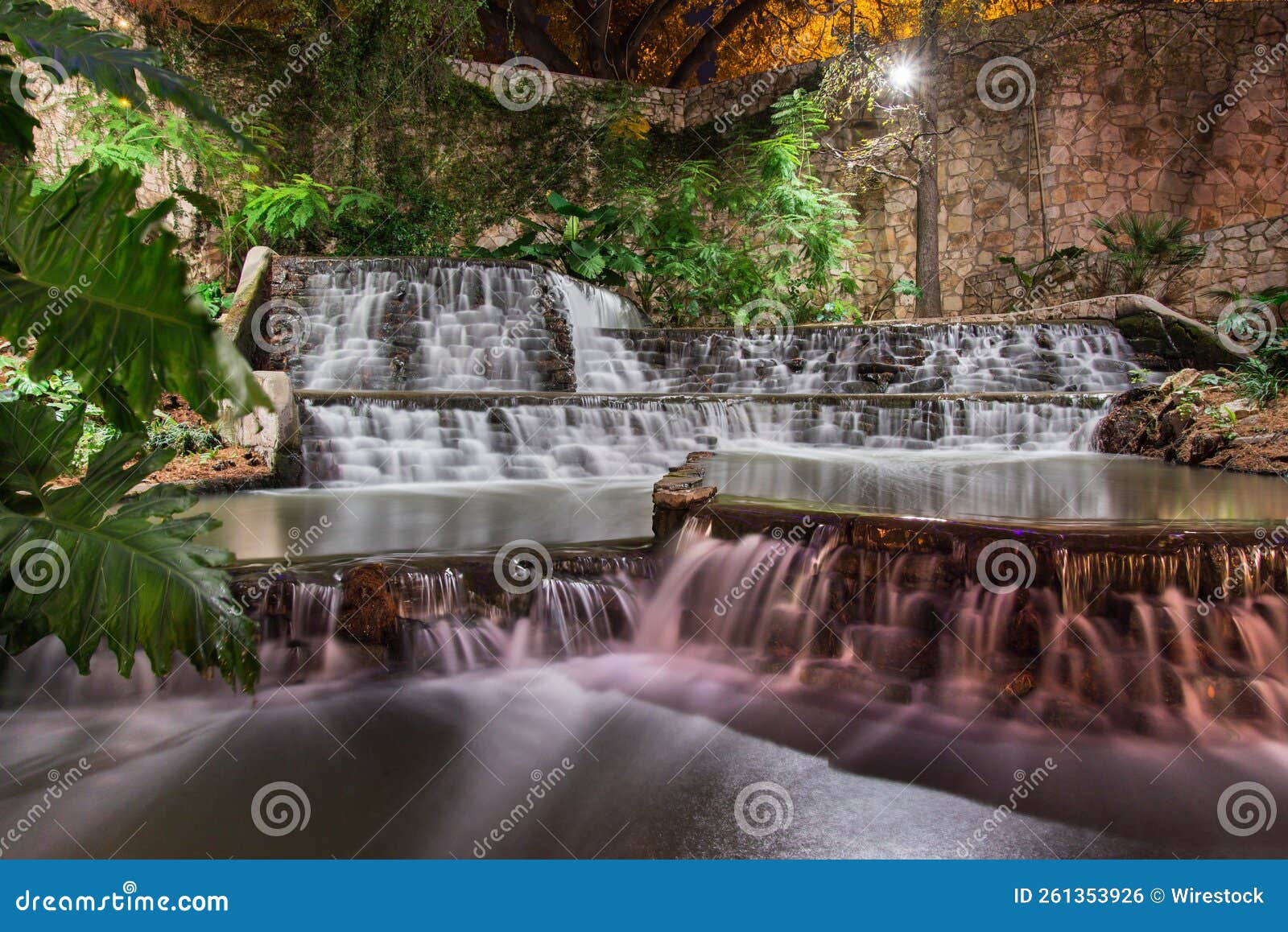 Long Exposure Shot of Waterfalls Surrounded by Brick Walls and Trees ...