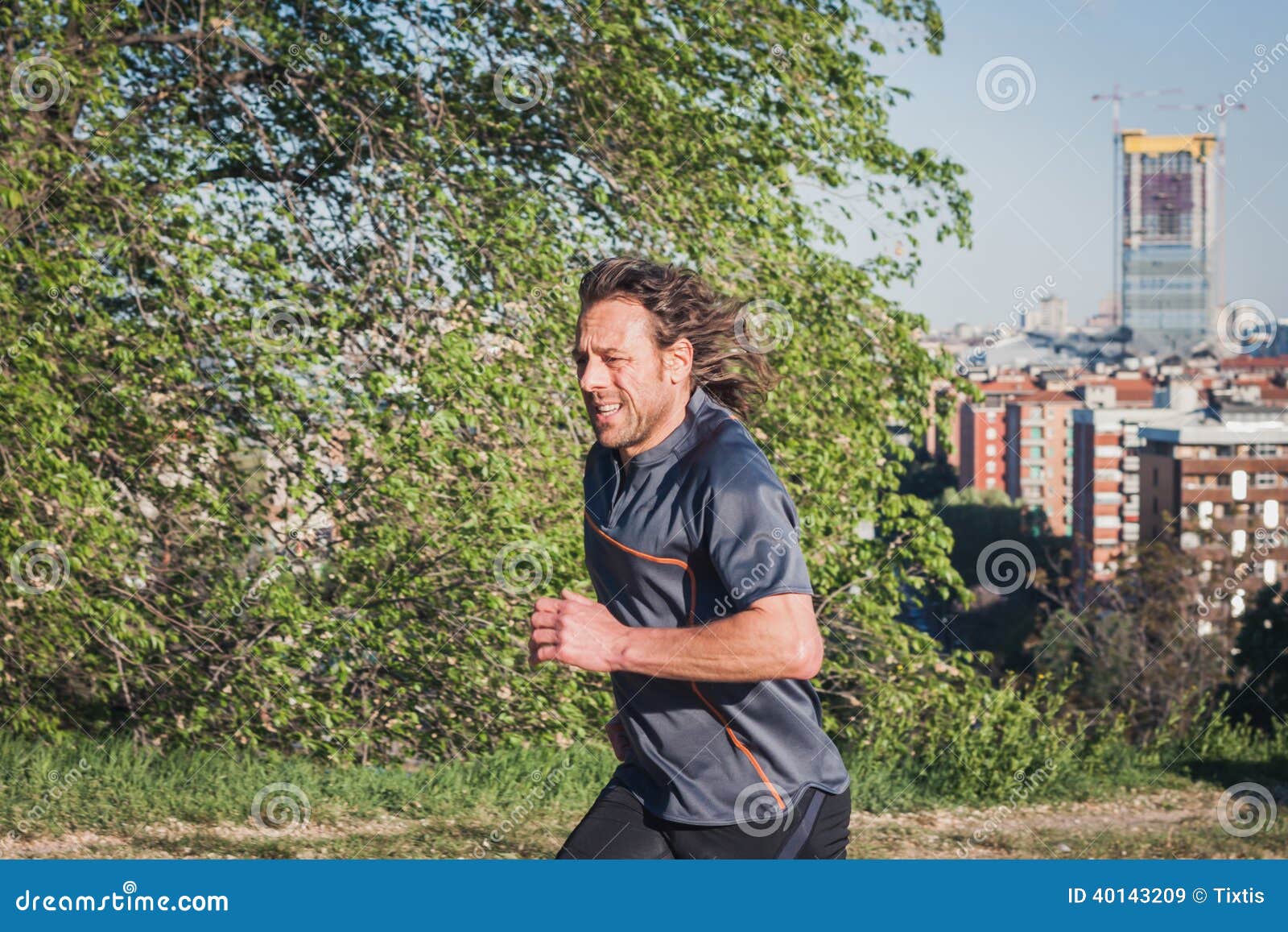 Long Haired Athlete Running in a City Park Stock Image - Image of ...