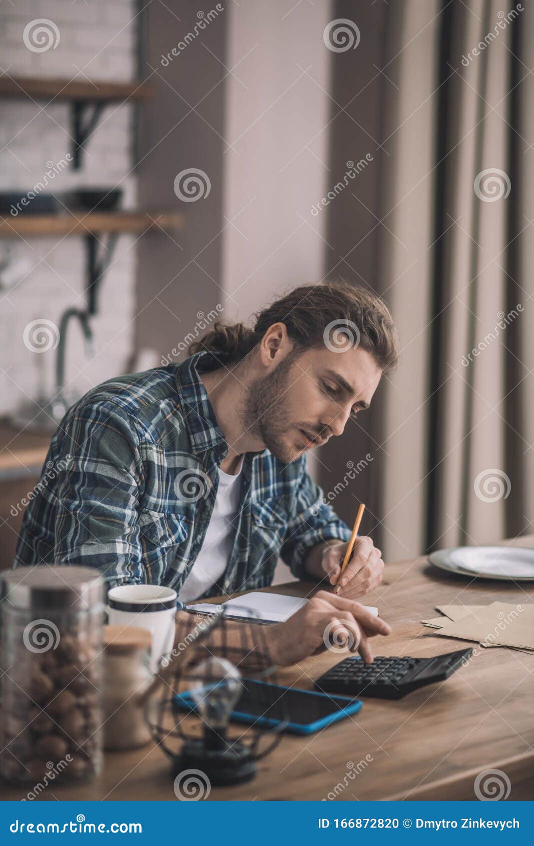 Long-haired Man Doing Precise Calculations for His Business. Stock ...