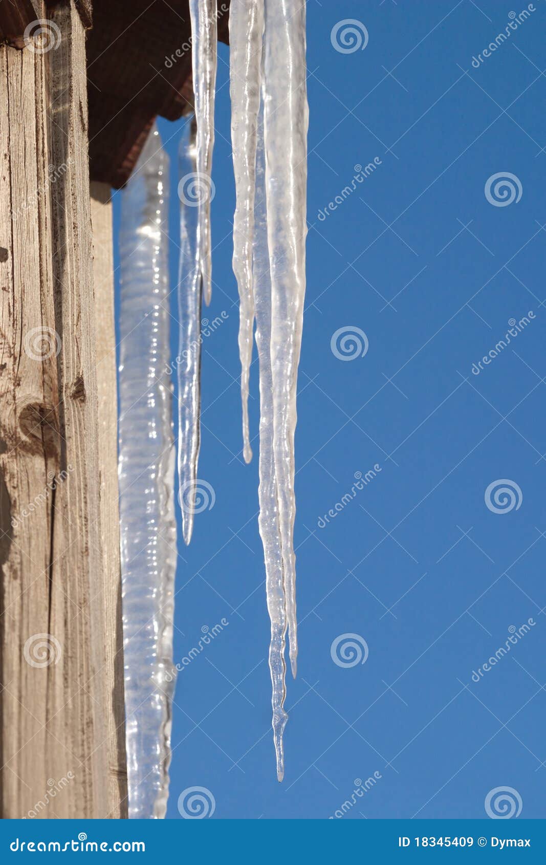 Long Icicles Hangs from a Roof Over Blue Cloudless Stock Image - Image ...