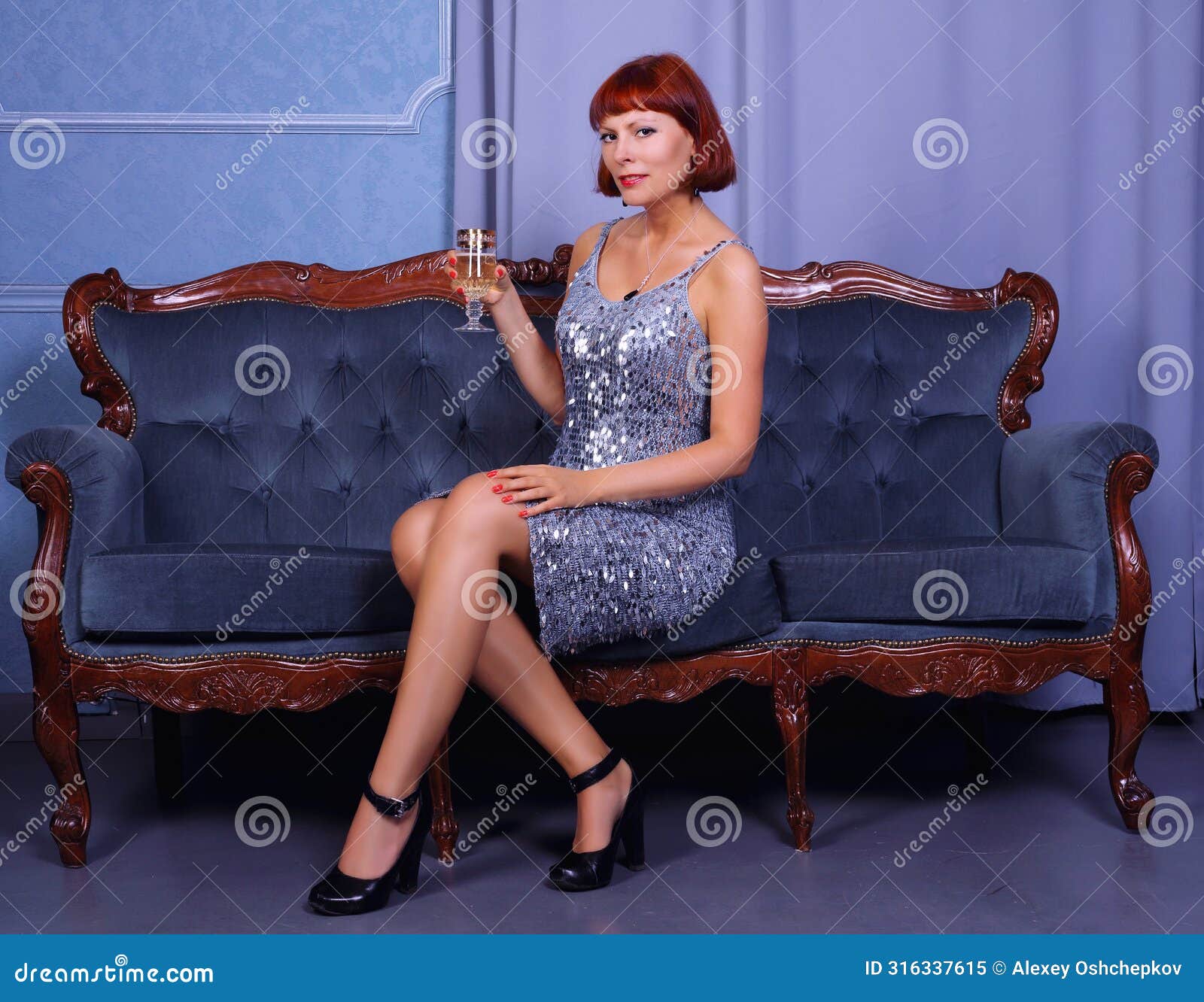 Long Legged Redhead Girl In Shiny Pantyhose And Silver Minidress Posing