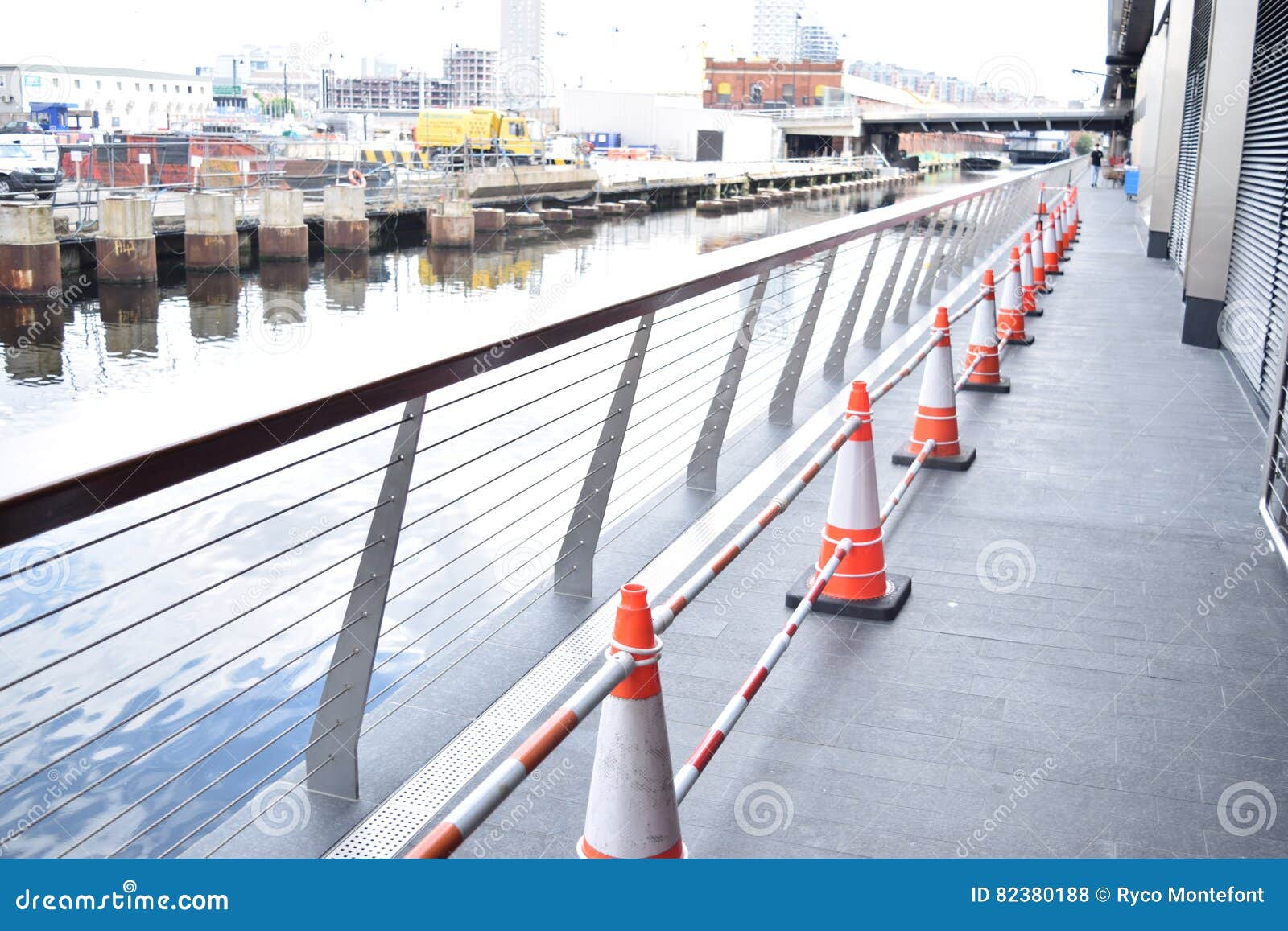Long Line of Red Cones Next To a Metallic Bridge Stock Photo - Image of ...
