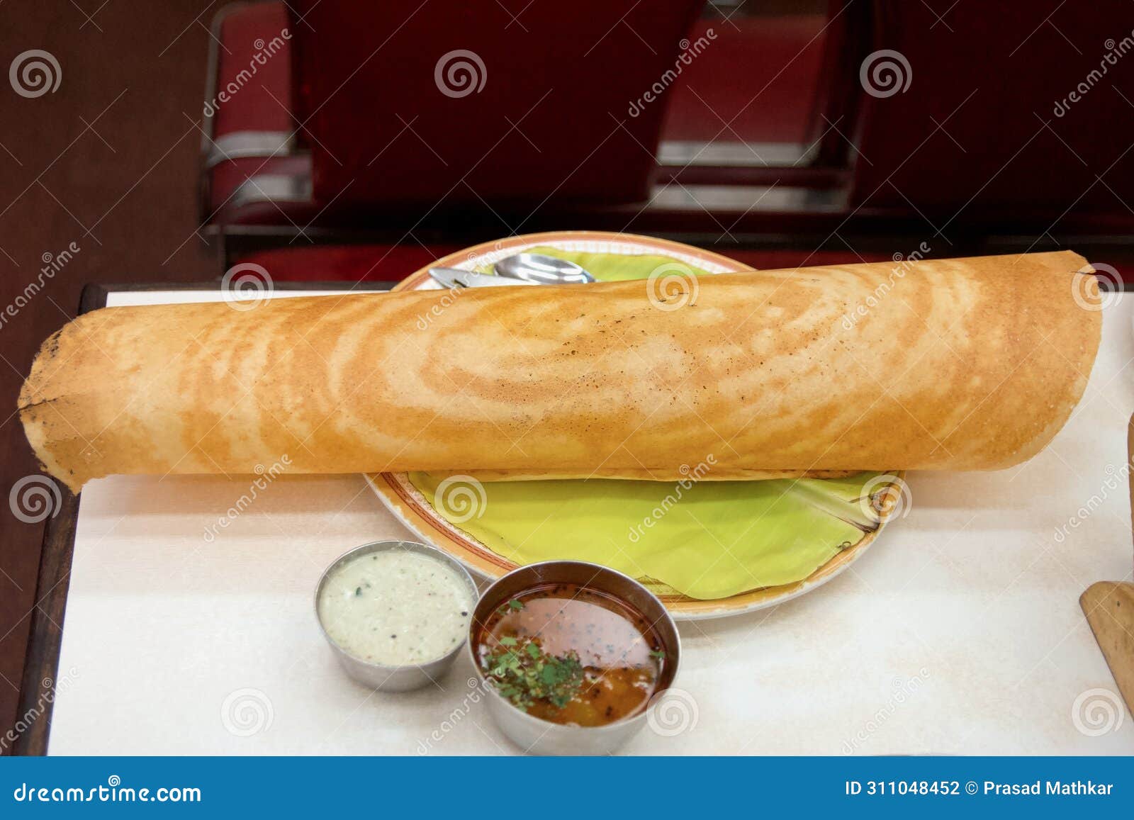 A Long Paper Thin Dosa Served with Coconut Chutney and Aromatic Sambar ...
