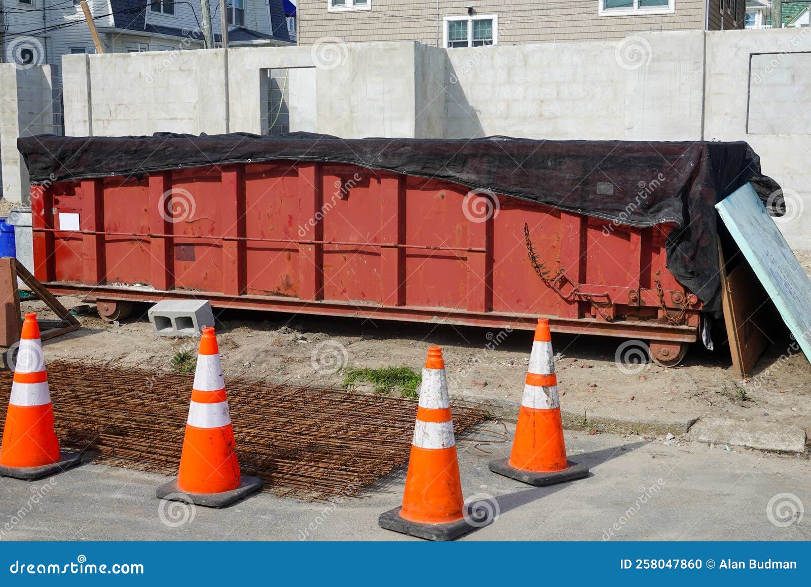 Long Red Covered Dumpster with Orange Warning Danger Cones in Front ...