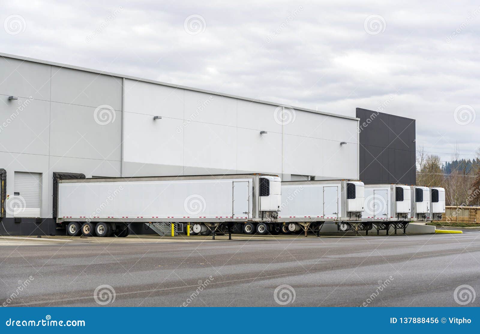 Long Refrigerator Semi Trailers Stand in Row in Warehouse Docks with ...