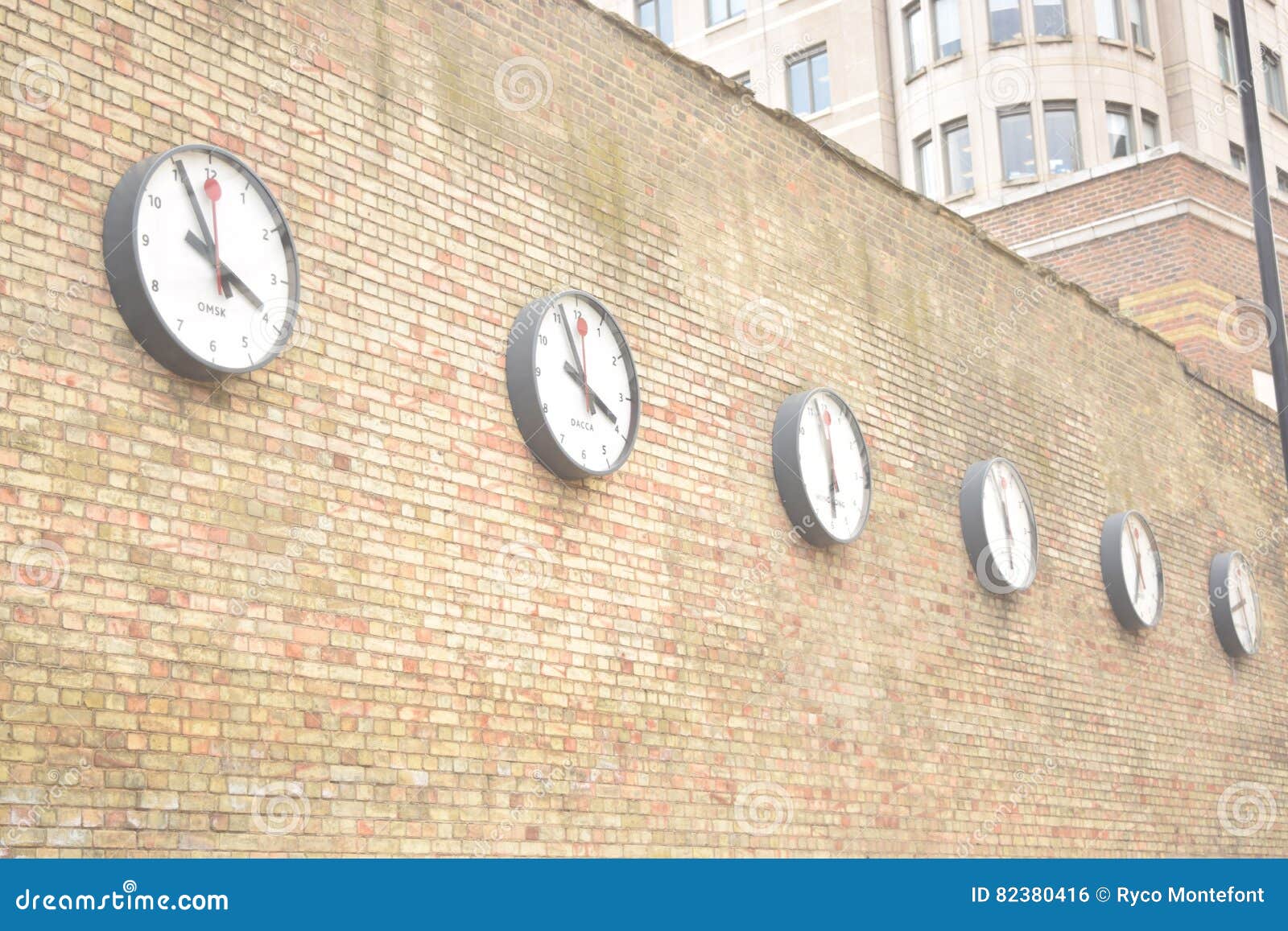 Long Row of White Clocks on a Brick Wall Stock Photo - Image of wall ...