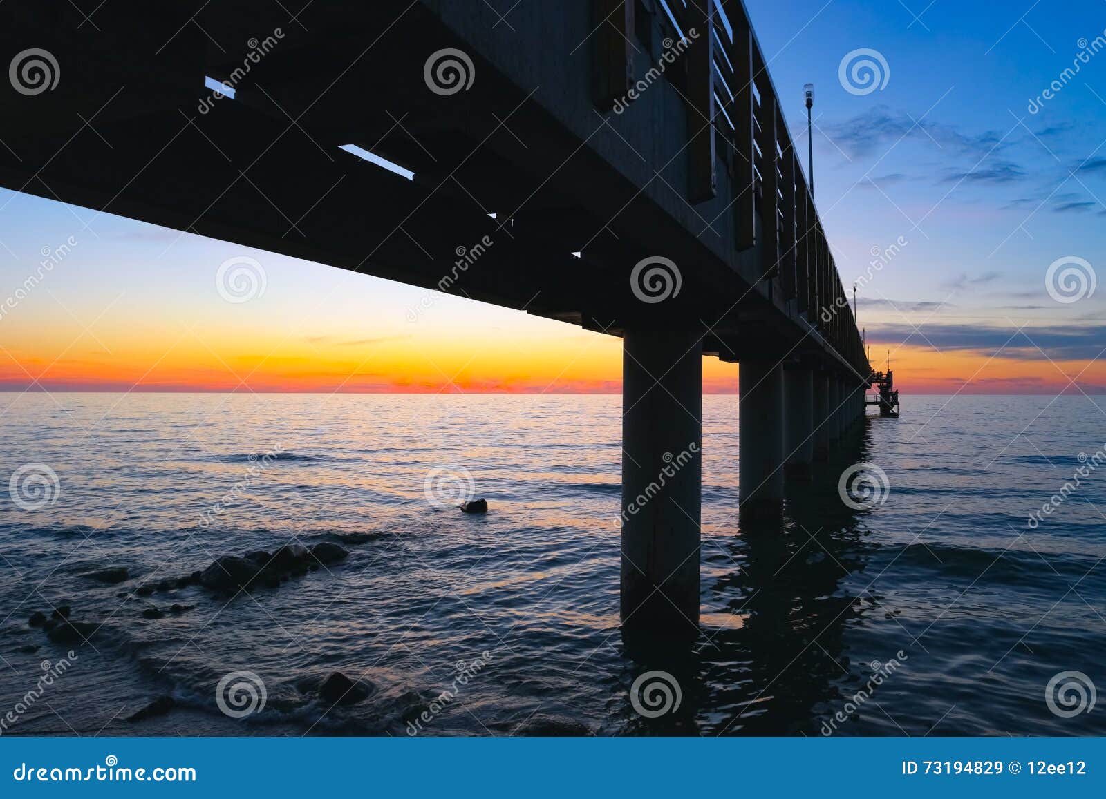 Long sea pier at sunset stock image. Image of baltic - 73194829