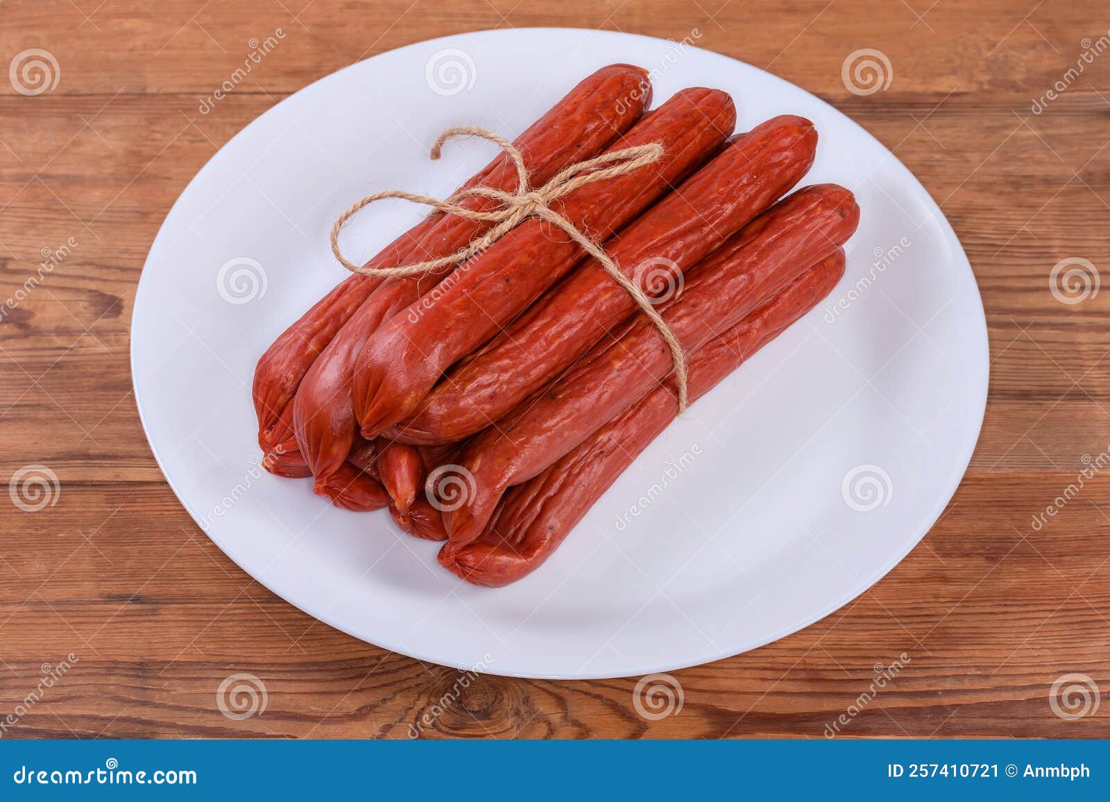Long Thin Smoked Sausages on Dish on Rustic Table Stock Image - Image ...