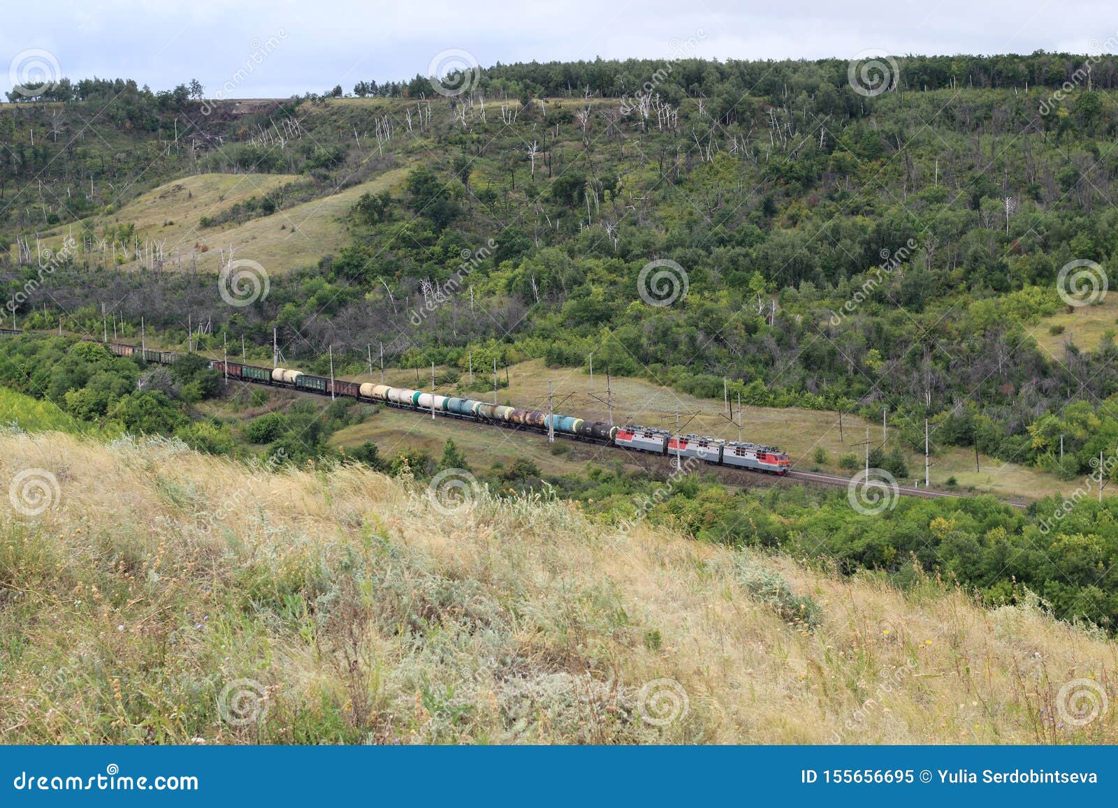 A Long Train Loaded with Double-stack Cargo Containers Winds Its Way ...
