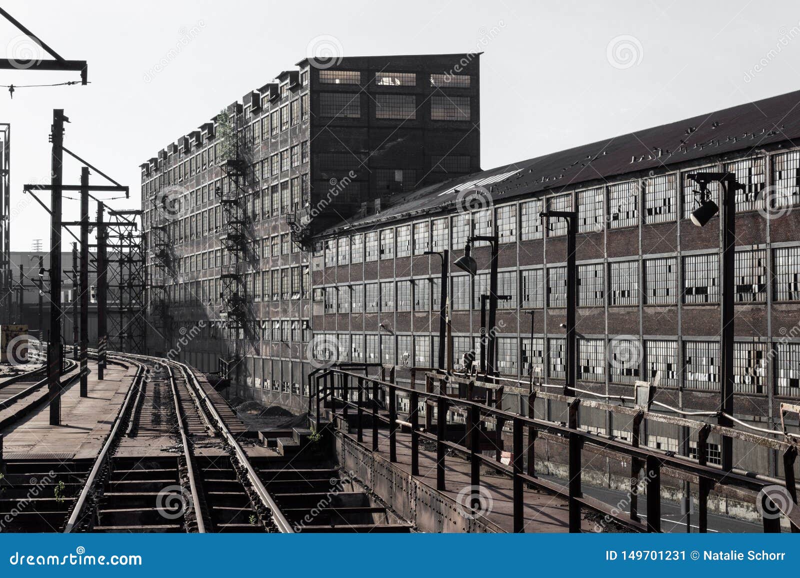 Long View of Train Tracks Alongside Expansive Warehouses of Brick with ...