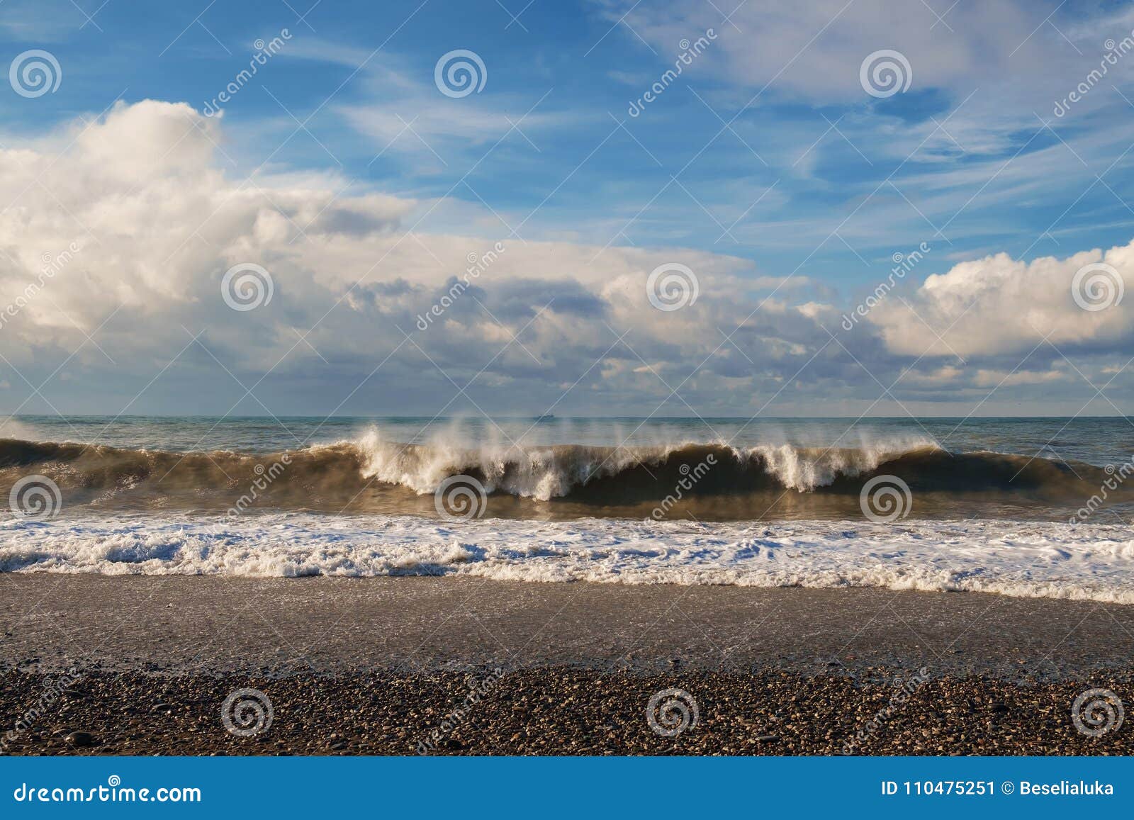 Long wave on a stony beach stock image. Image of scenery - 110475251